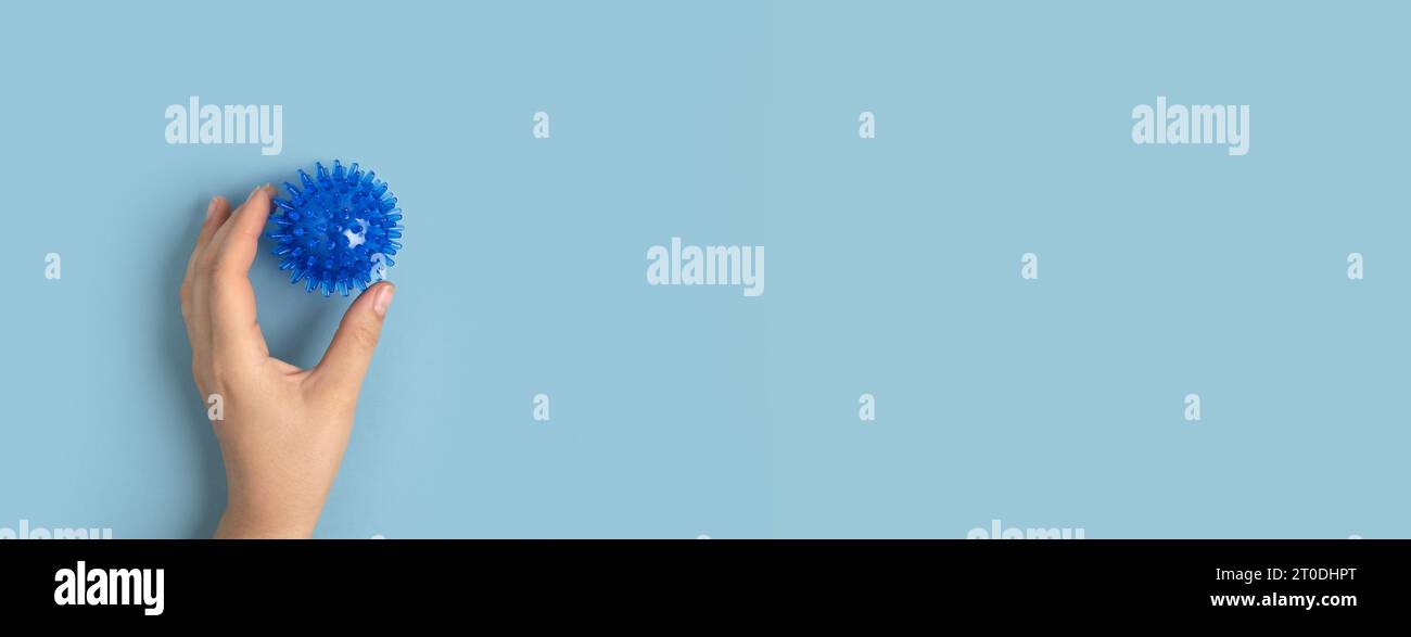 Tactile knobby ball on blue studio background. Sensory massage textured ...