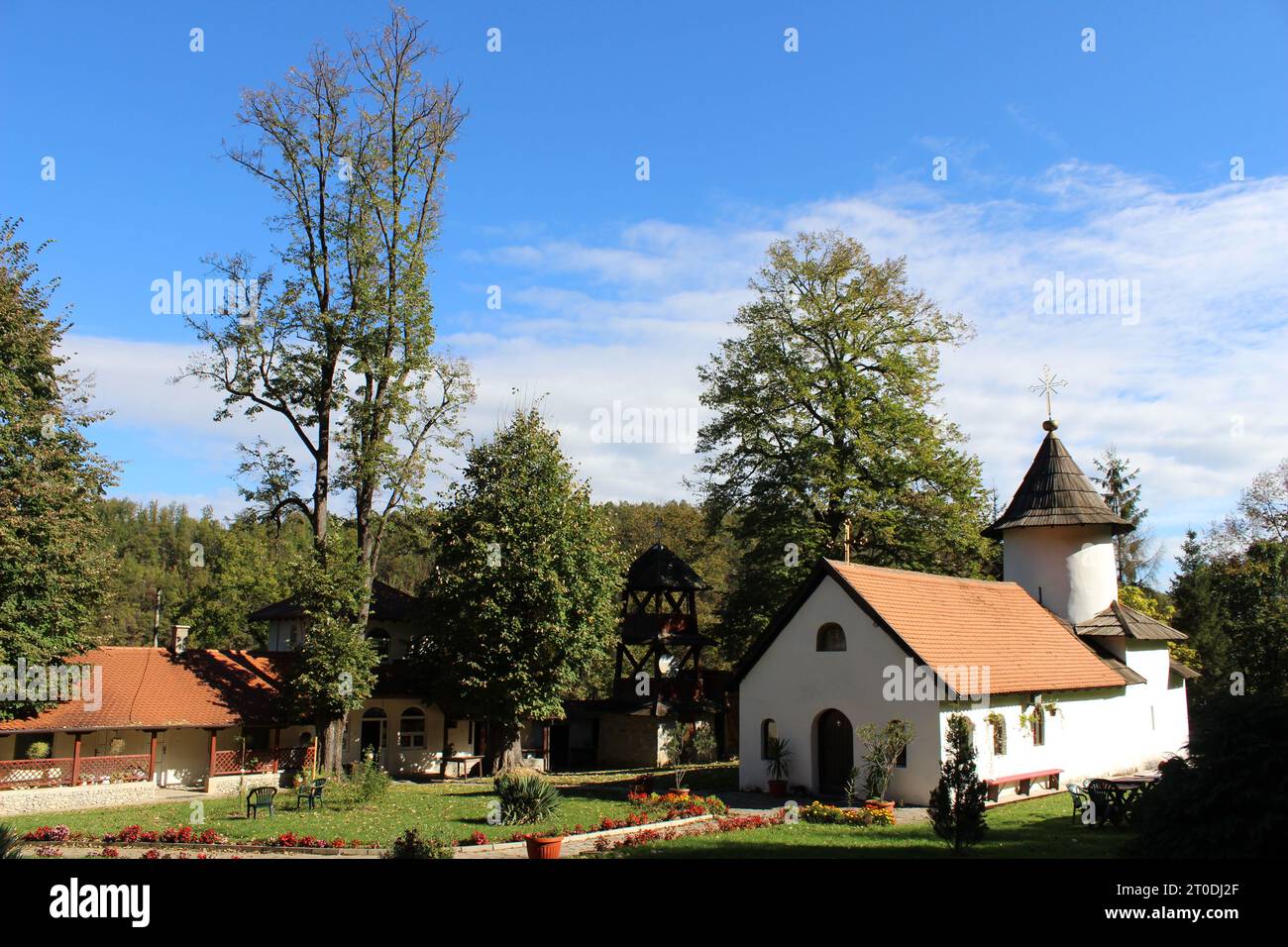 A tranquil scene of a majestic white cottage, its bell tower reaching ...