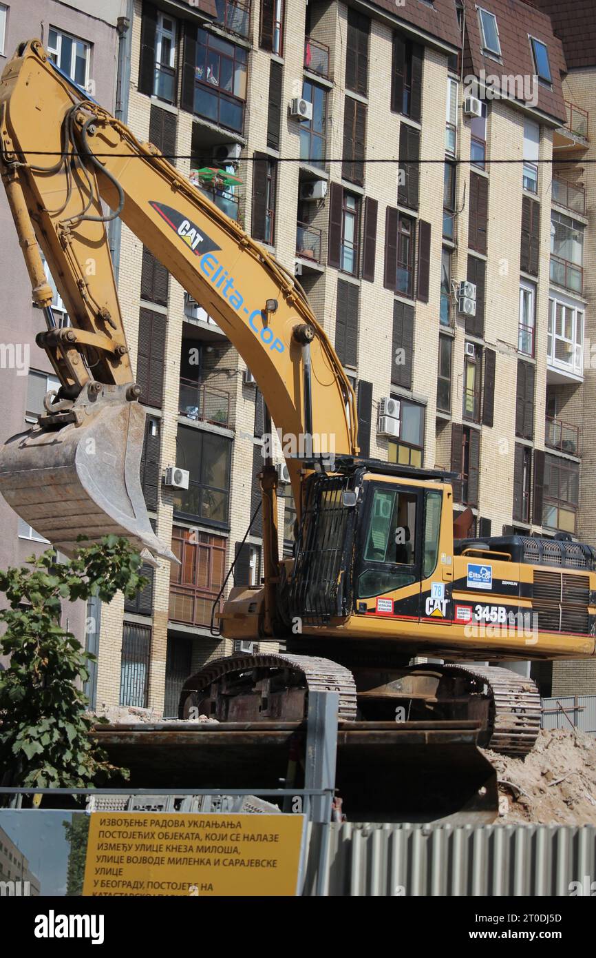 A bright yellow construction vehicle, with its massive bucket and ...