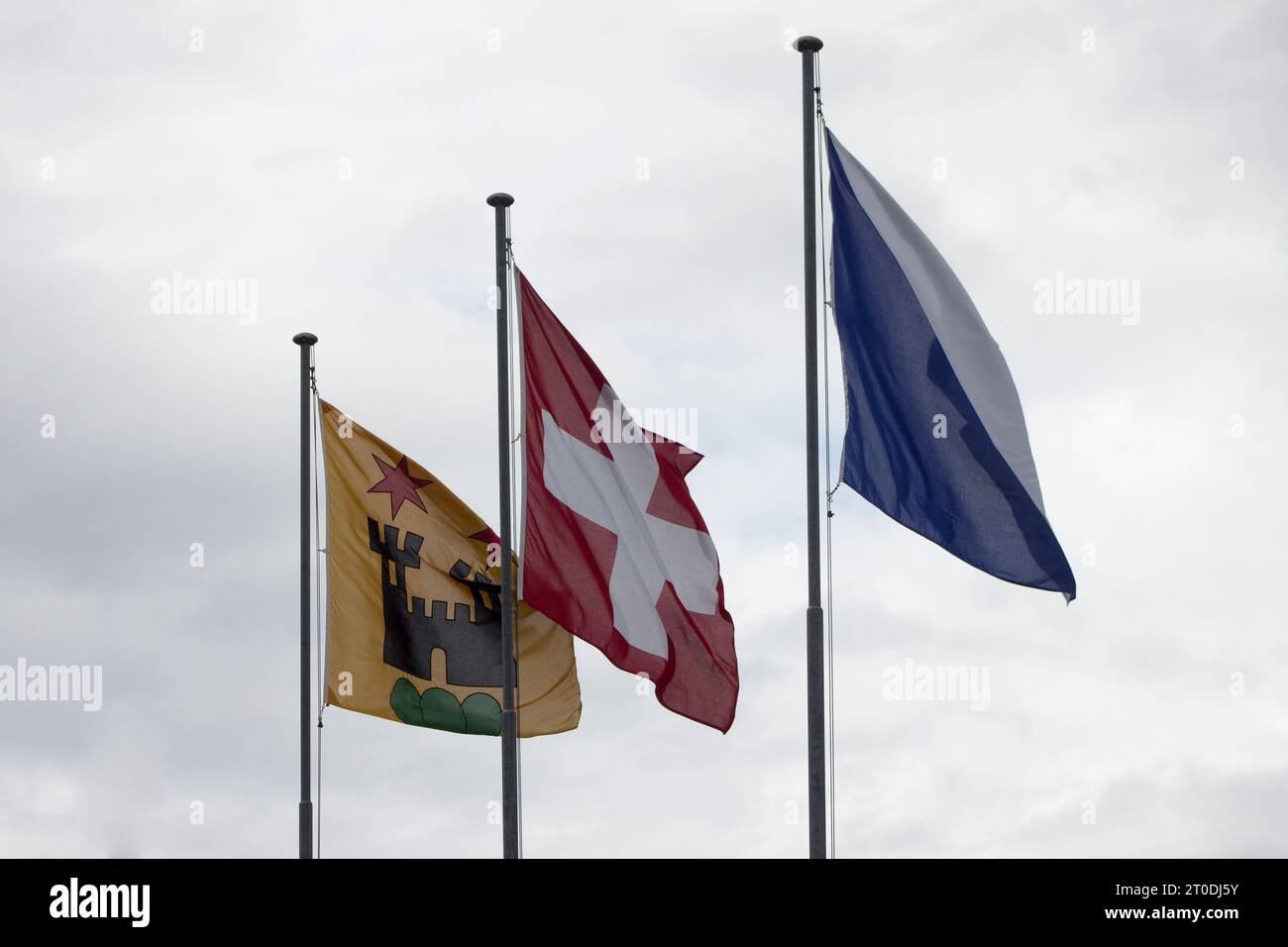 A colorful array of flags wave in the breeze against a clear blue sky ...