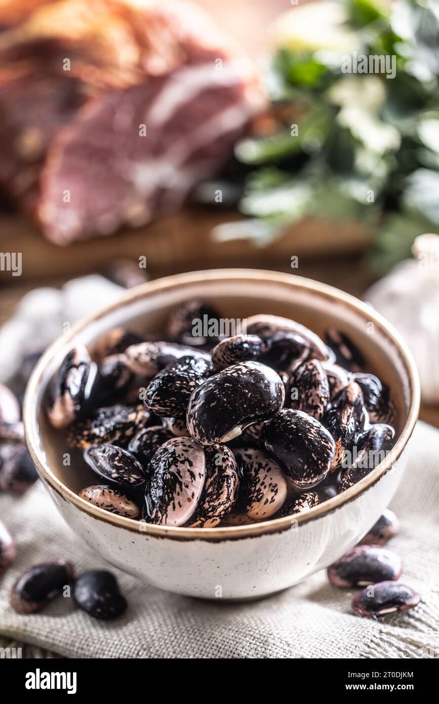 Raw beans in a bowl soaked in water the day before cooking to soften ...