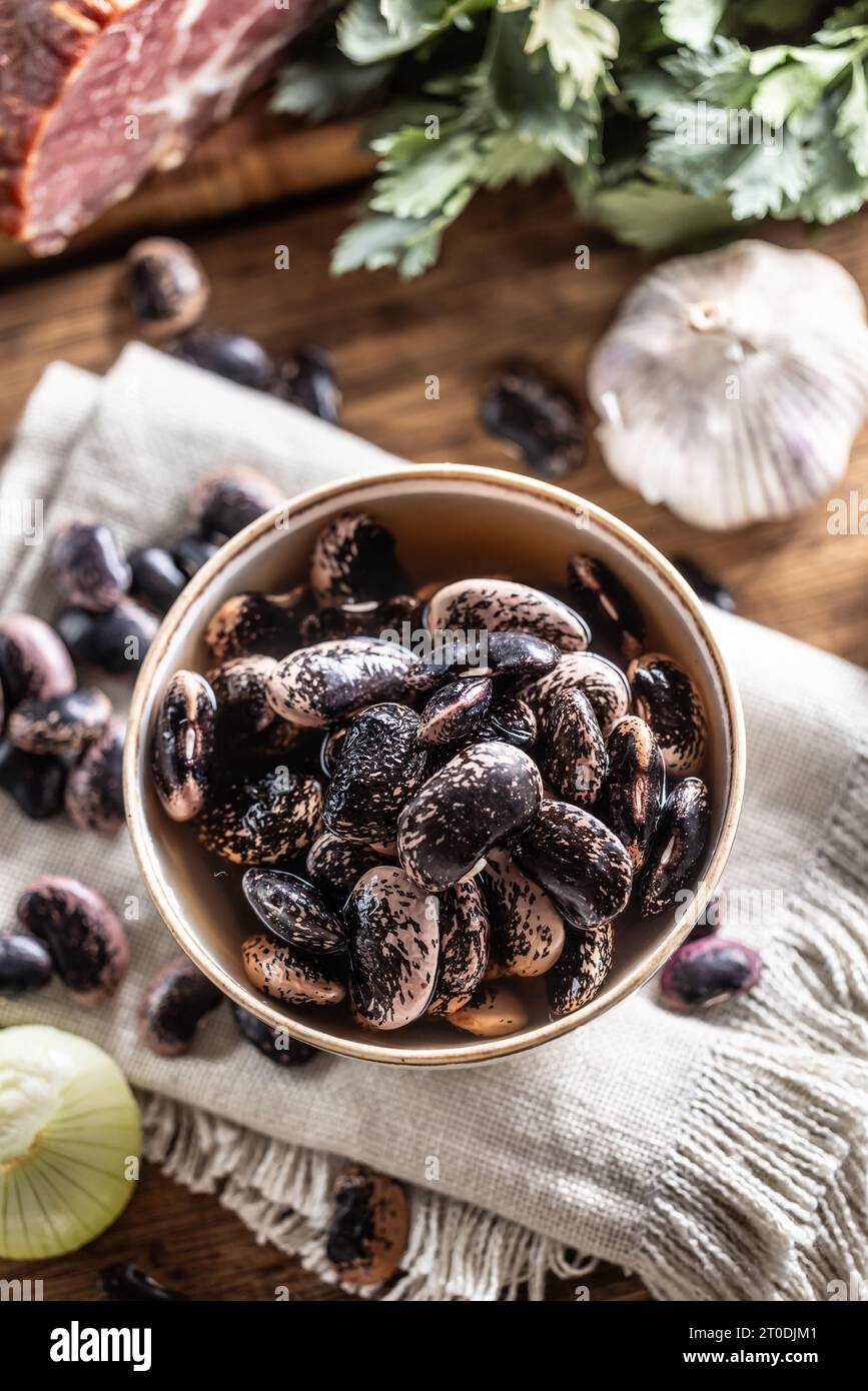 Raw beans in a bowl soaked in water the day before cooking to soften ...