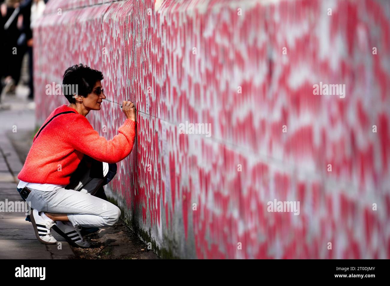 Members of the public observe the National Covid Memorial Wall, a ...