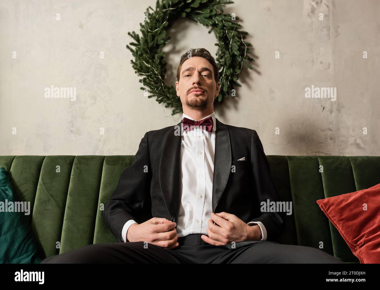 wealthy gentleman with beard wearing tuxedo with bow tie sitting on ...