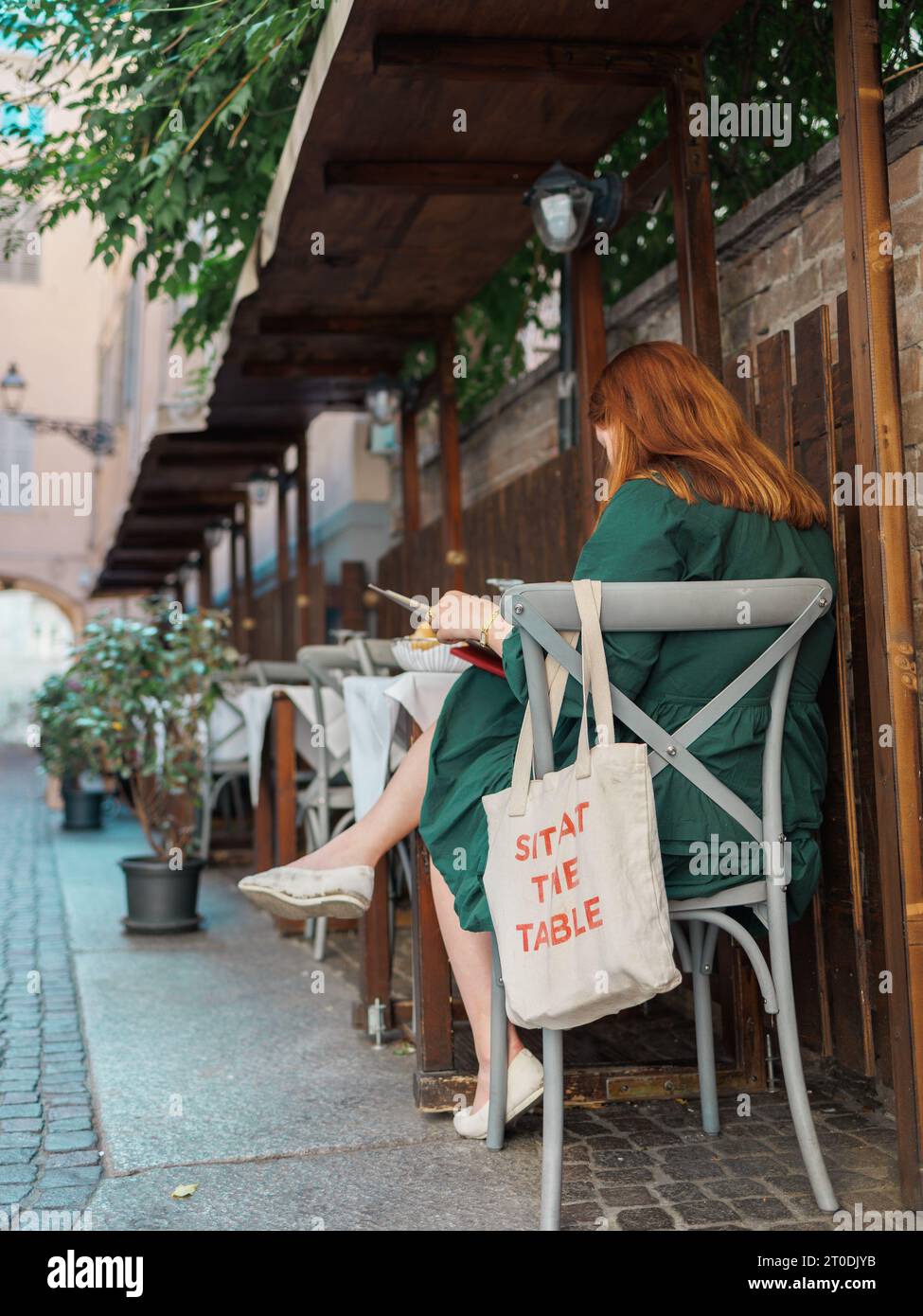 Woman alone at table cafe travel hi-res stock photography and images ...