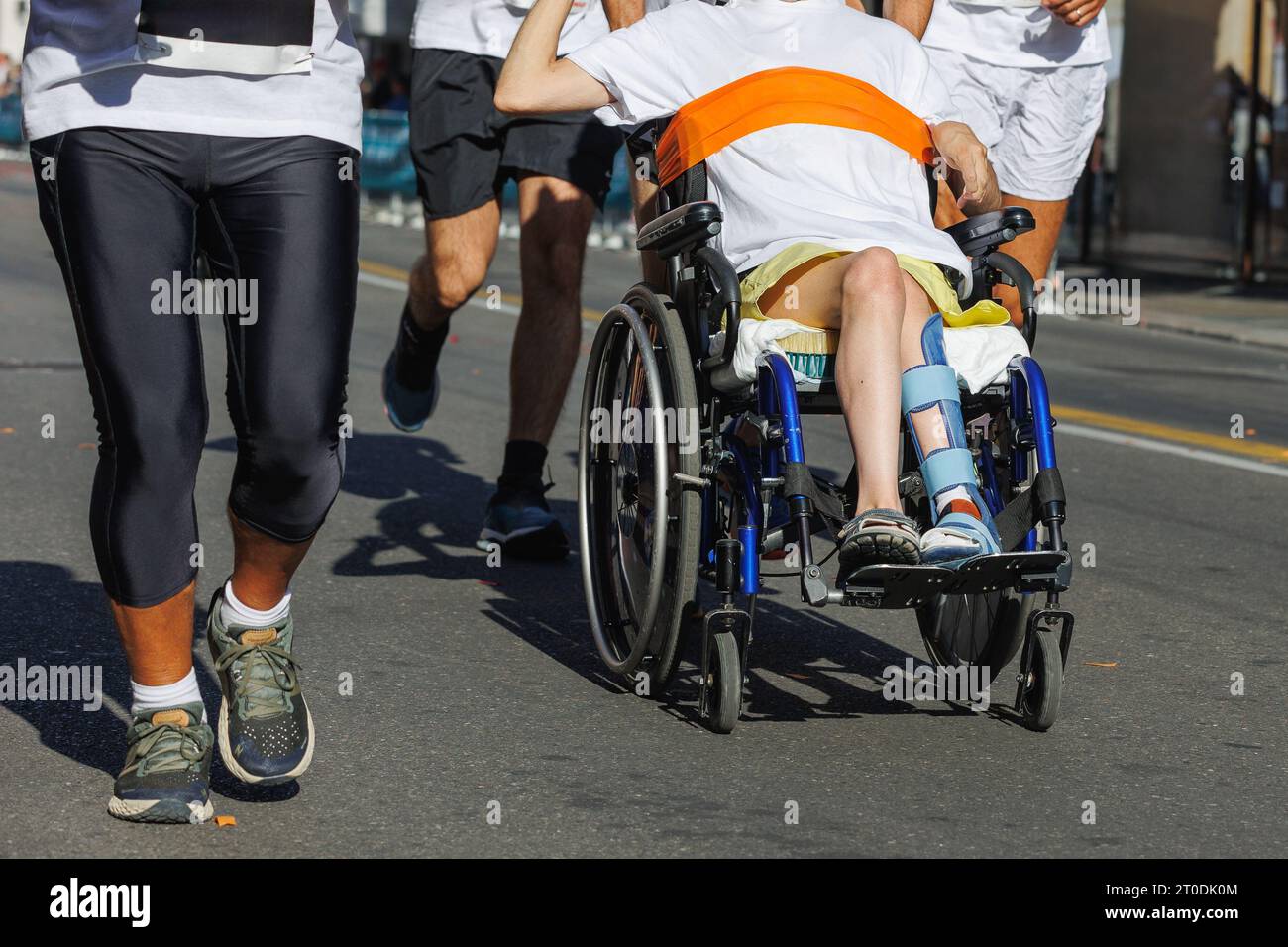 Athletes Runners and Boy in a Wheelchair during Sport Marathon Stock ...