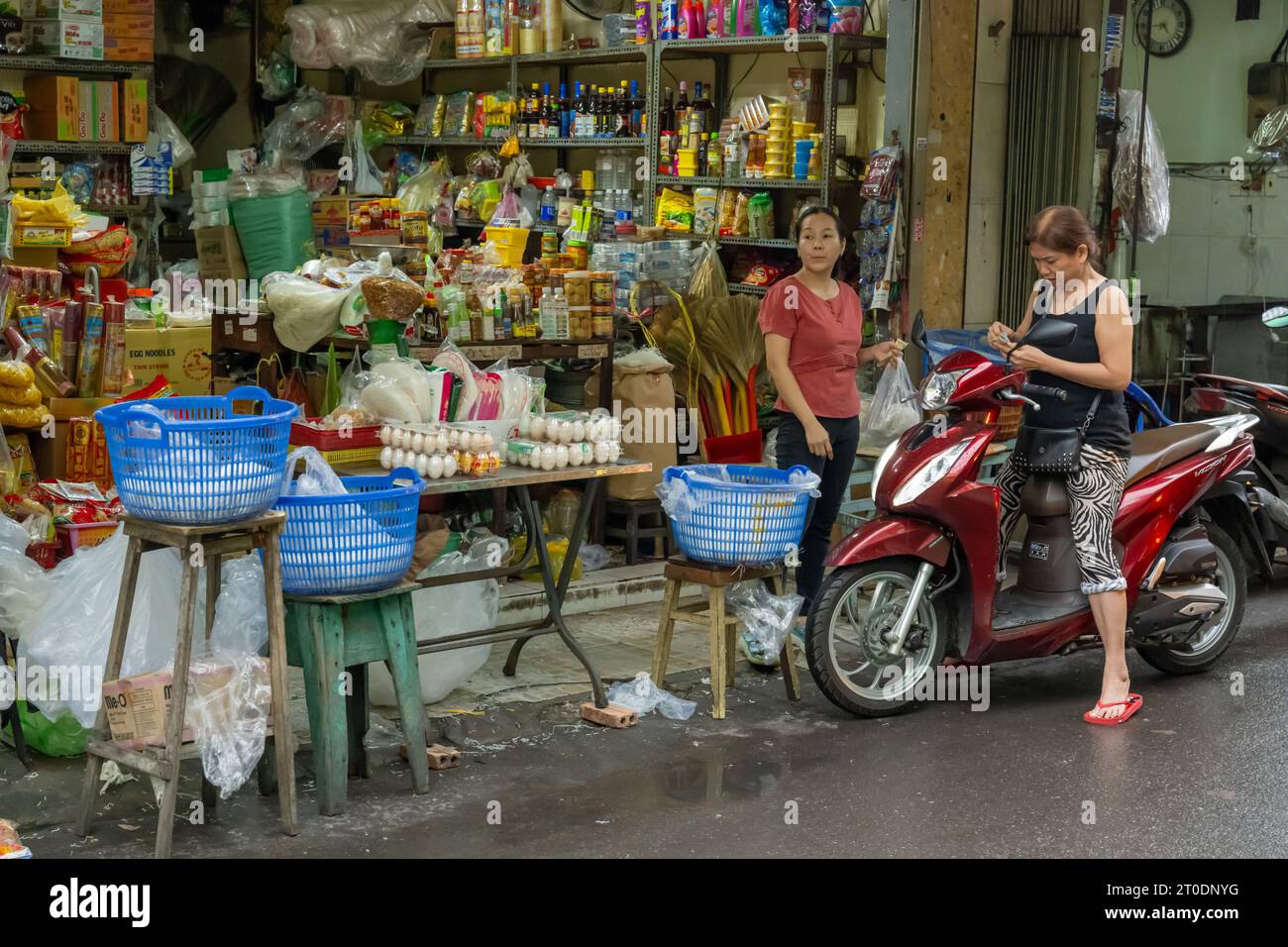 Buying goods from a Vietnamese general store on the street, Ho Chi Minh ...