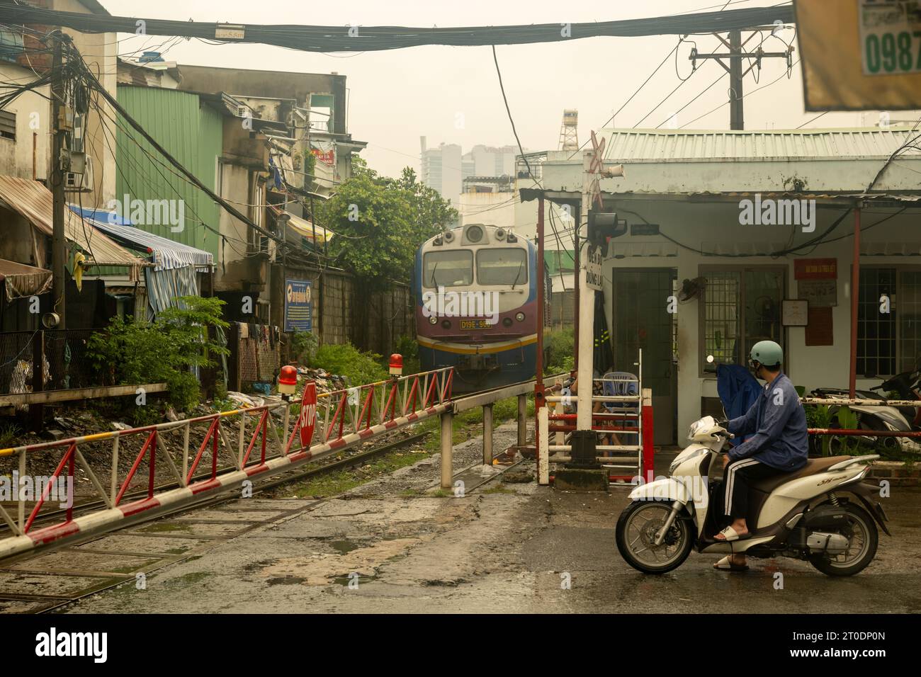 Train passing through the famous Saigon railway level crossing, Ho Chi ...