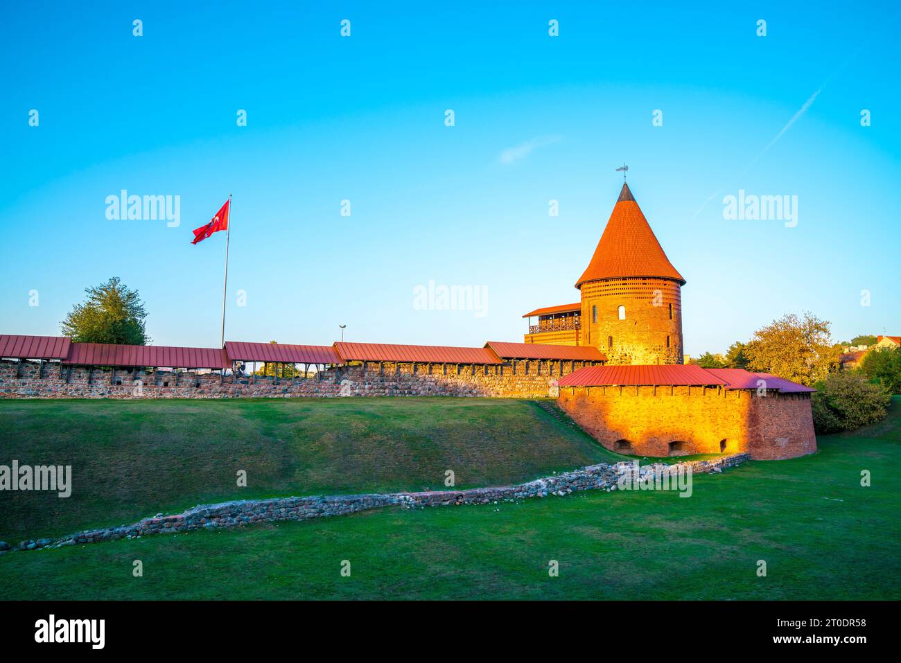 Lithuania, Kaunas castle building and flag in warm sunset light ...
