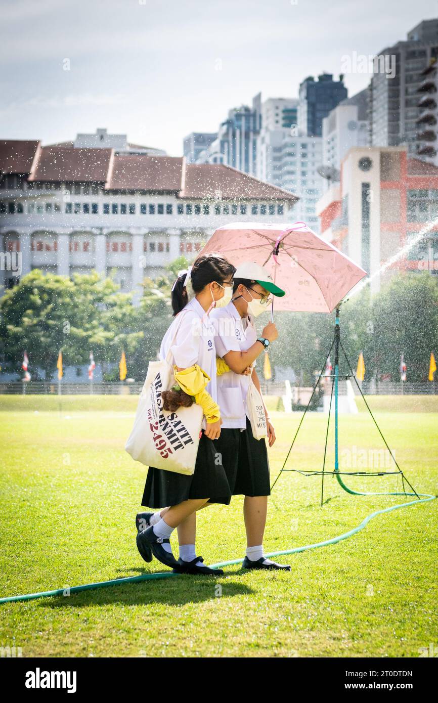Thai university students wander across the main lawn of ...