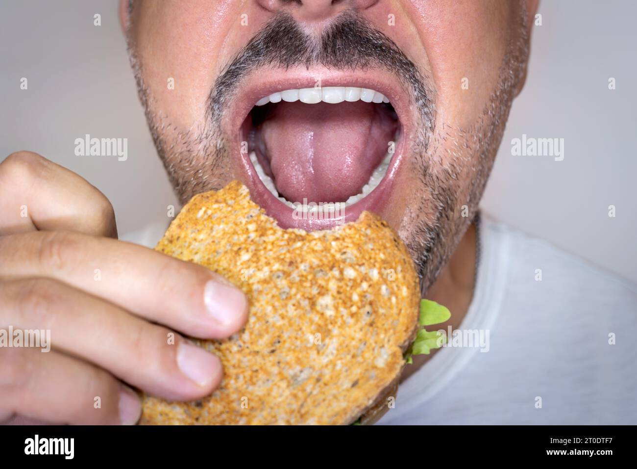 Funny man eating hamburger hi-res stock photography and images - Alamy
