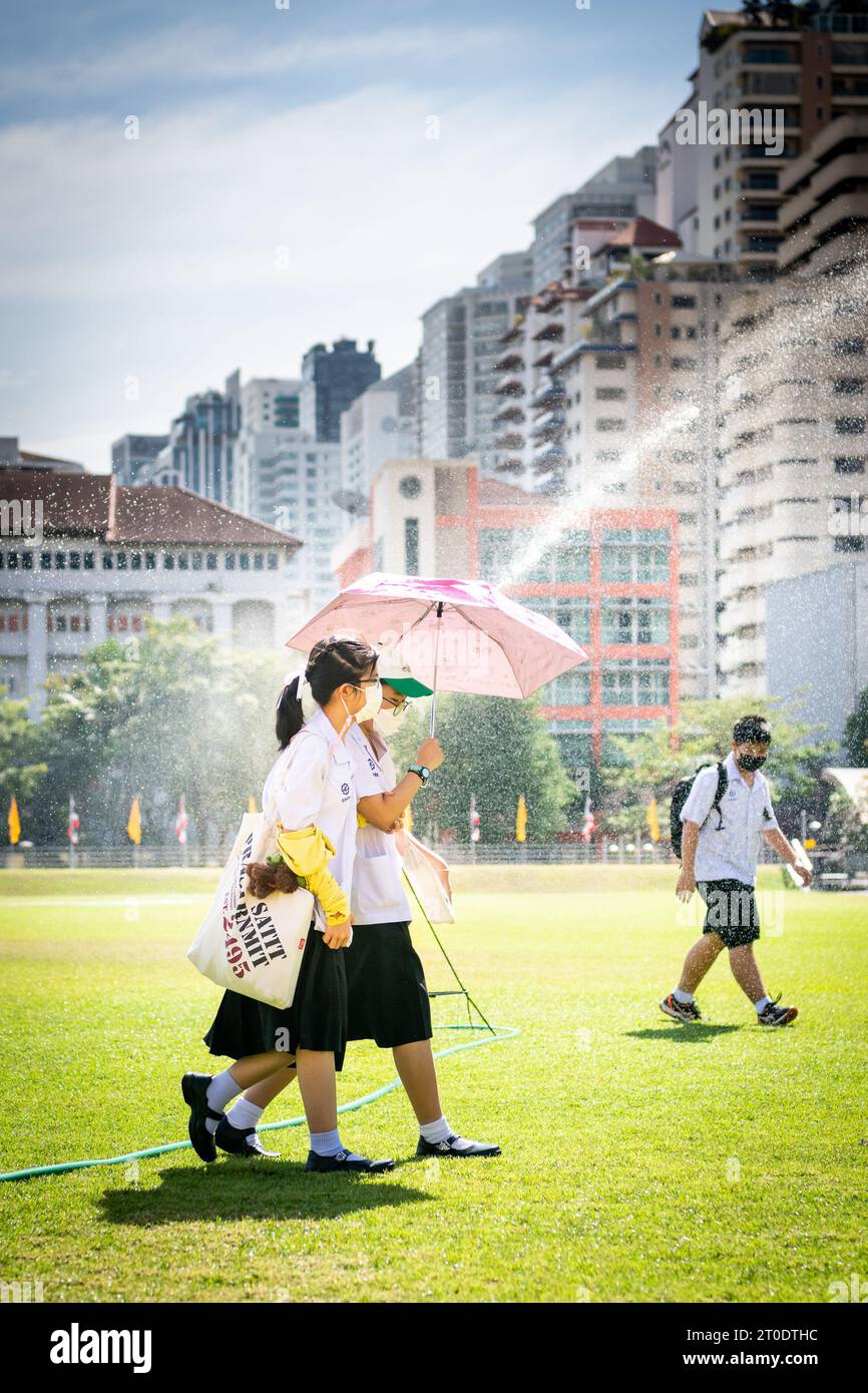 Thai university students wander across the main lawn of Srinakharinwirot University Bangkok ...