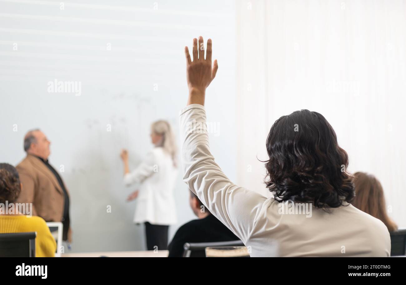 Businessman rises hand up for the question in the diverse employees ...