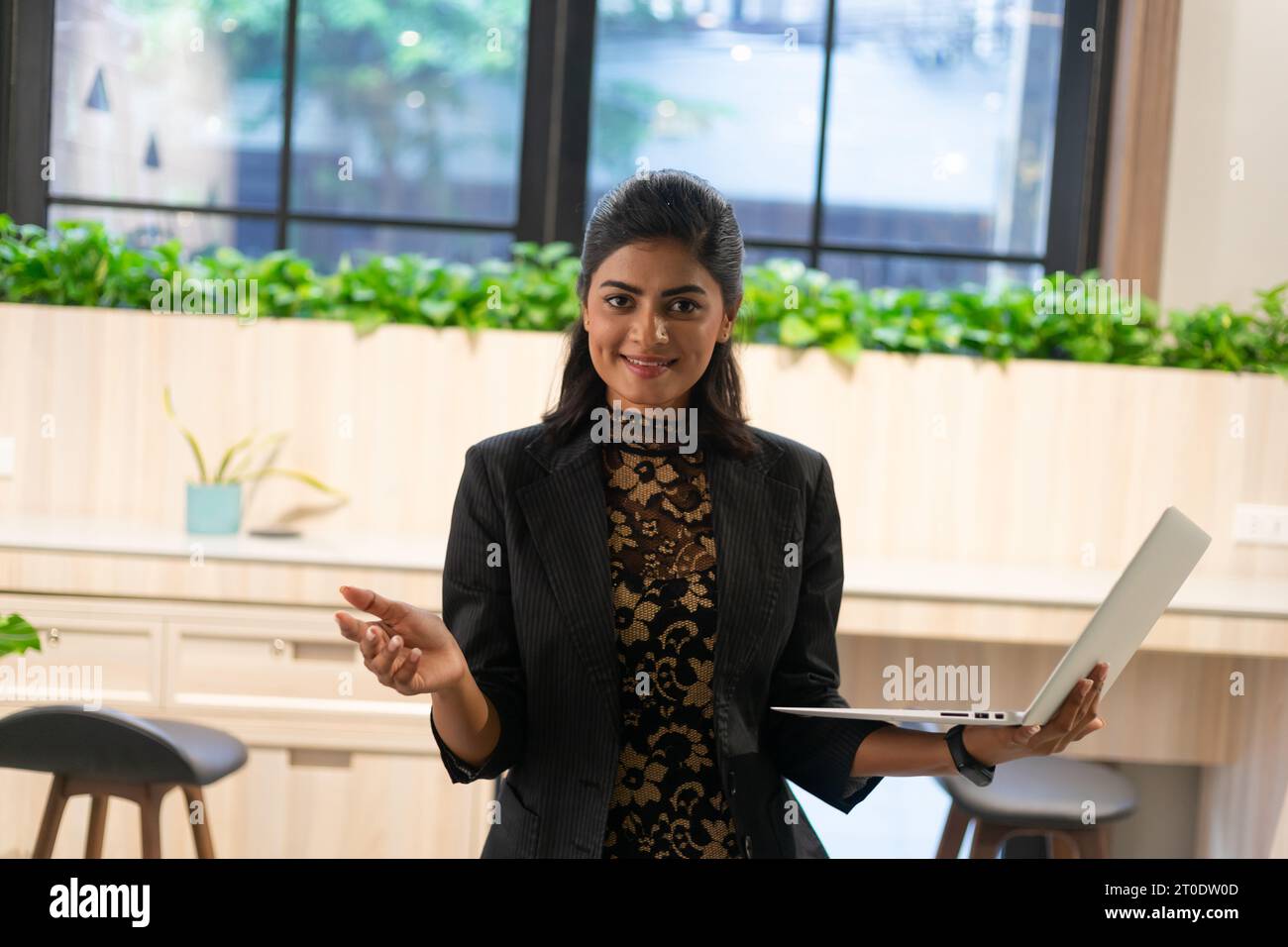 Happy young Asian saleswoman holding laptop. Smiling business woman ...