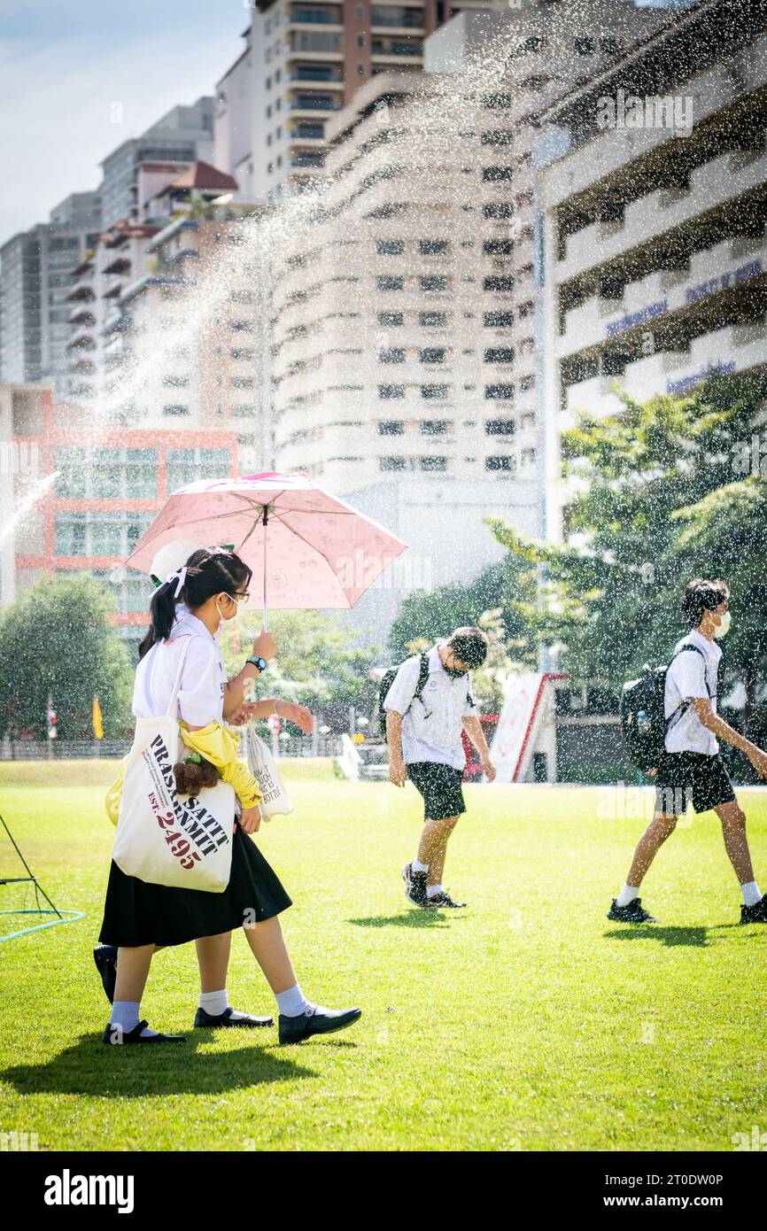 Thai university students wander across the main lawn of ...