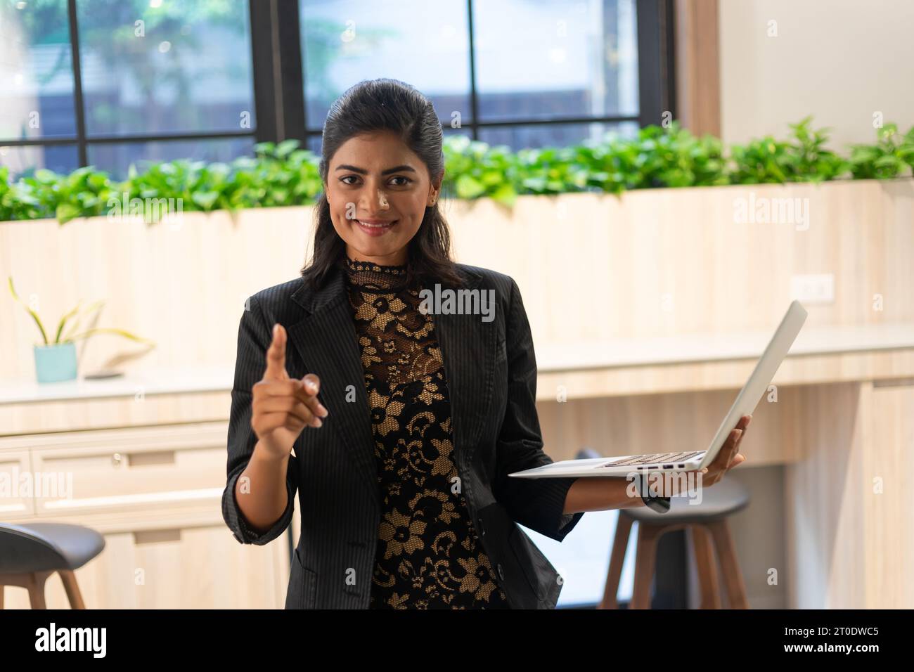Happy young Asian saleswoman holding laptop. Smiling business woman ...