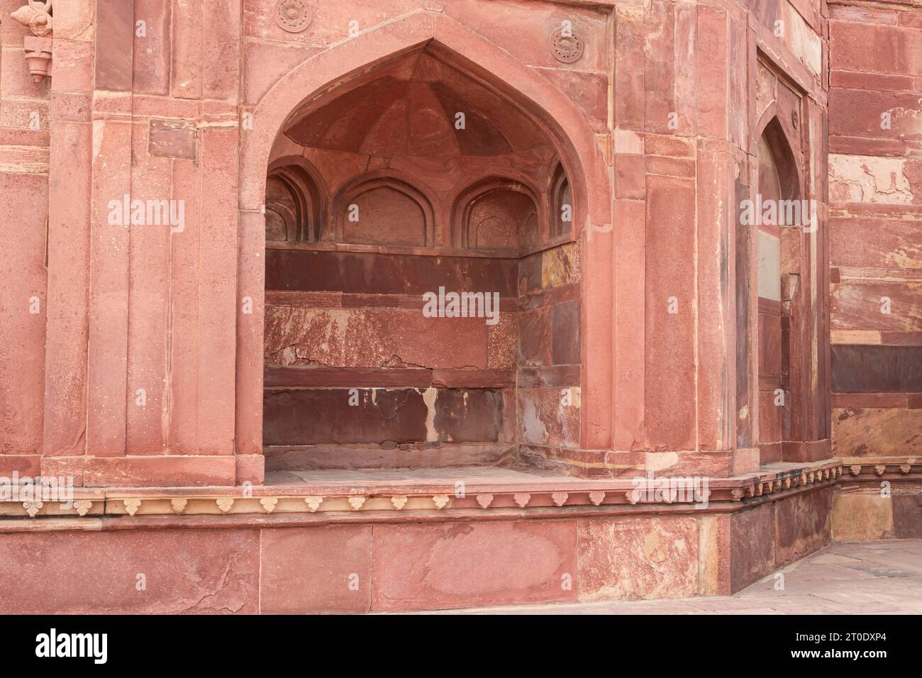 Ancient arched cove of a red stone Indian fort building Stock Photo - Alamy