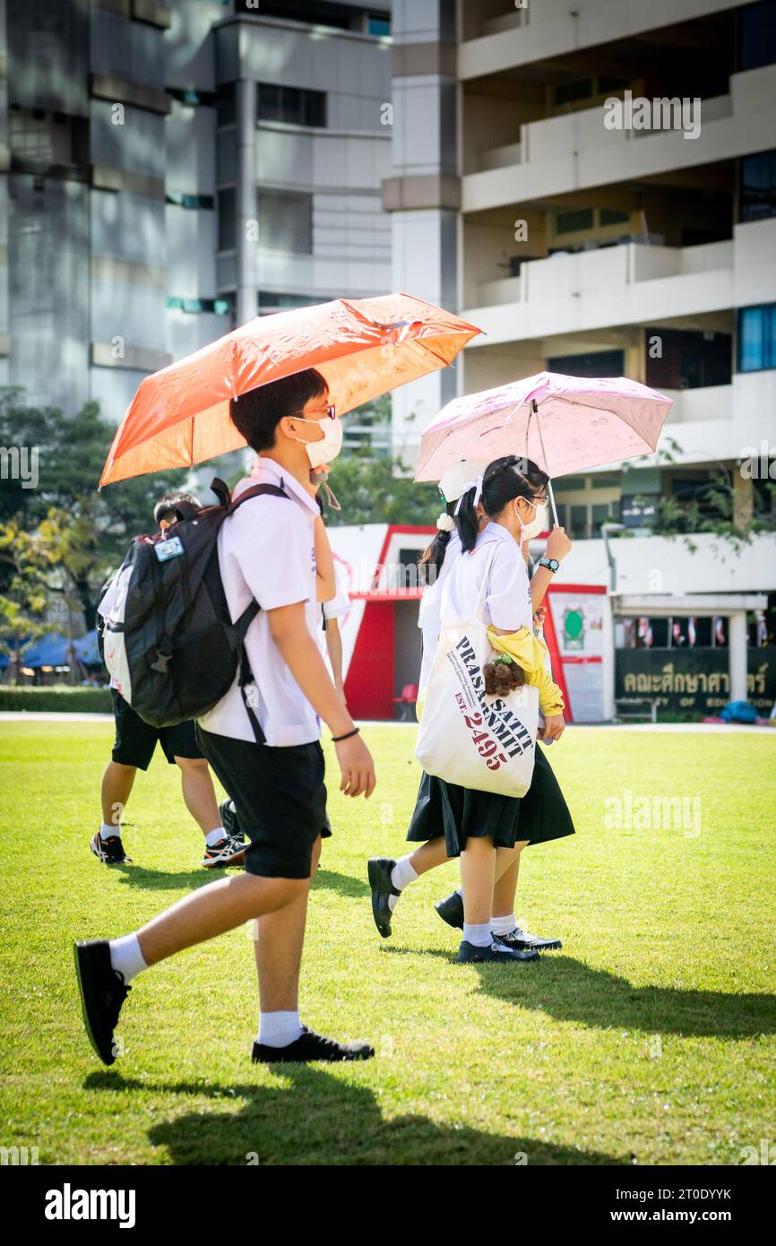 Thai university students wander across the main lawn of ...