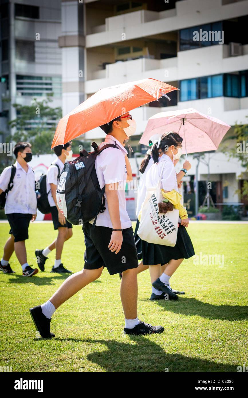Thai university students wander across the main lawn of ...