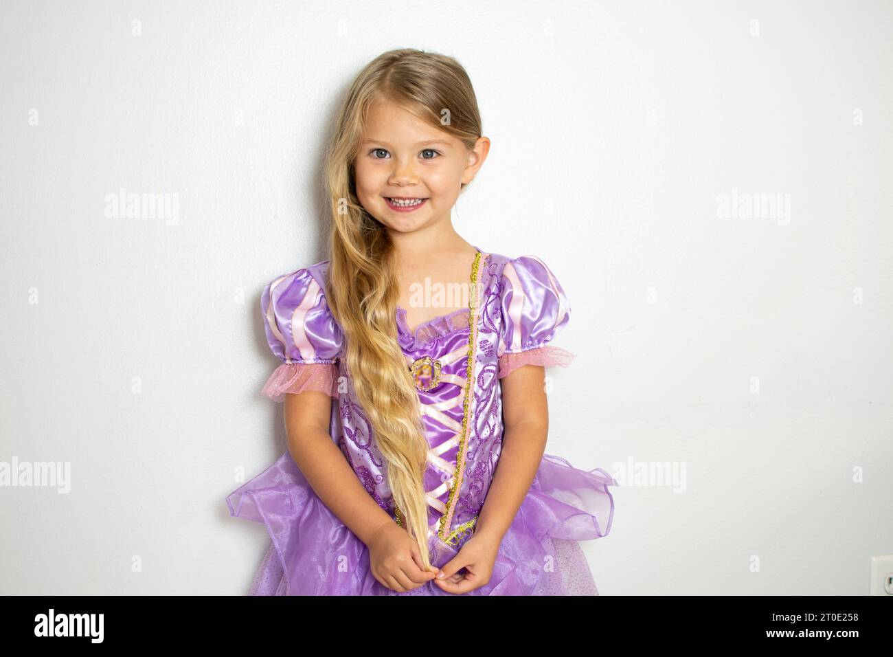 A cute smiling Caucasian little girl in Halloween costume. Child in a ...