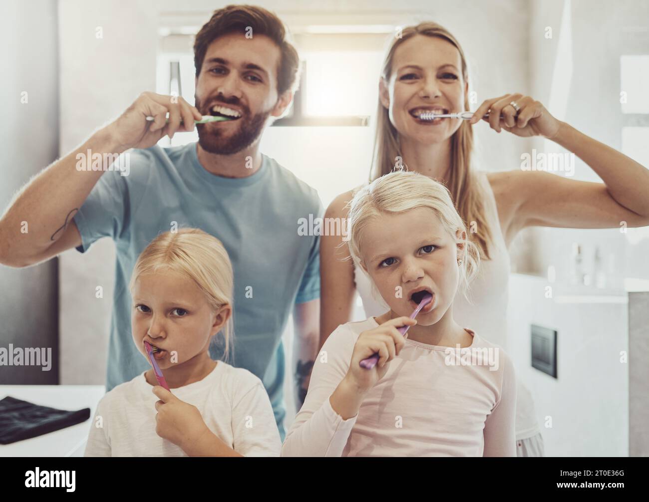 Portrait, family and brushing teeth with girl children in the bathroom ...
