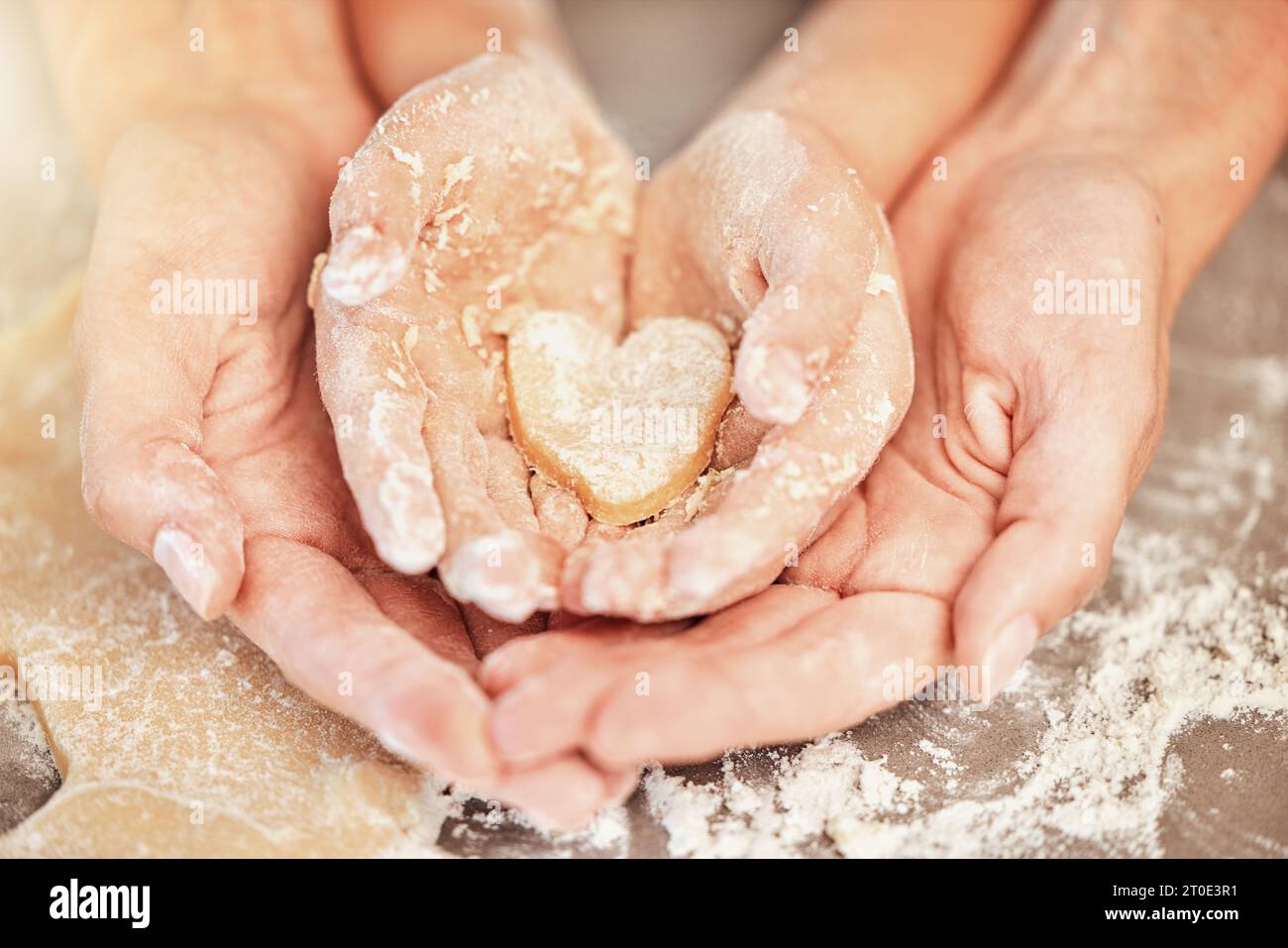 Hands, baking and heart with mother, kid and bonding together as ...