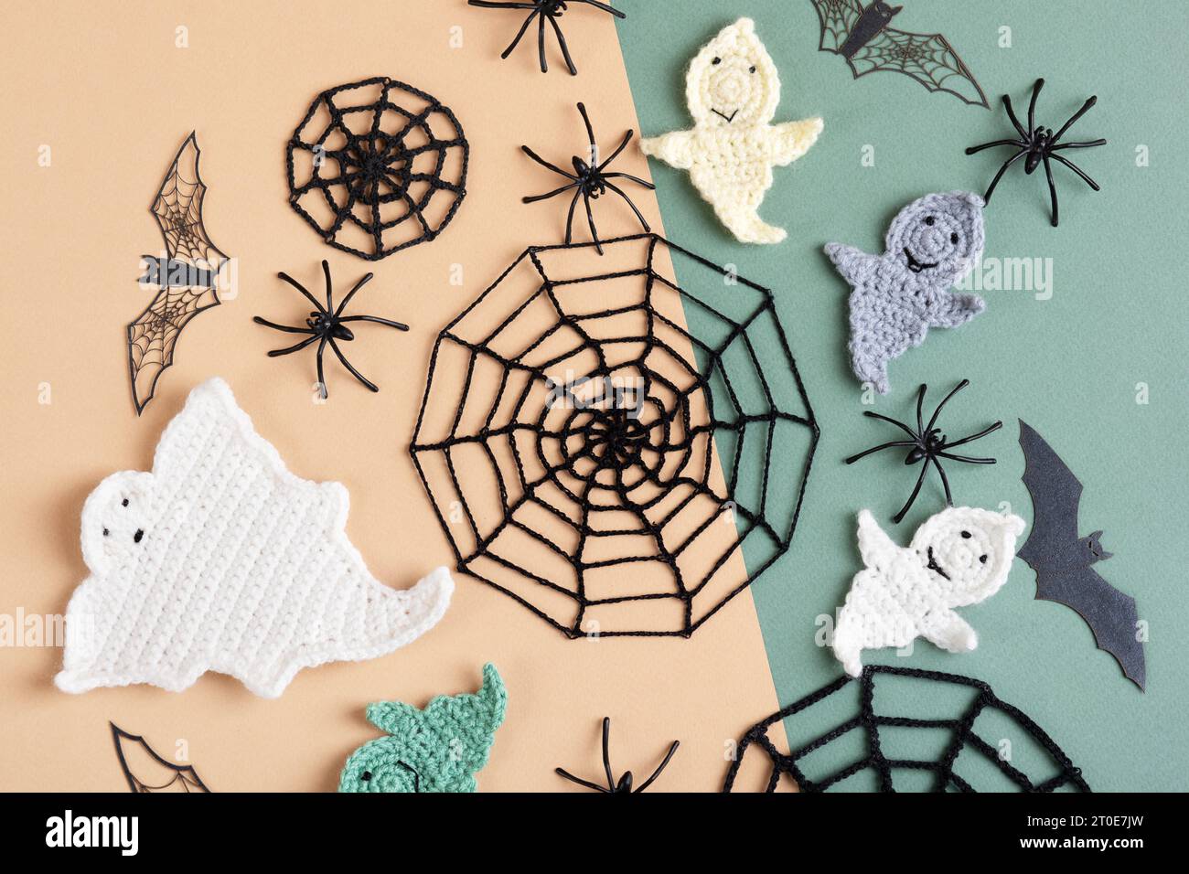 Halloween decorations, ghost, spiders, bats, knitted webs on green and ...