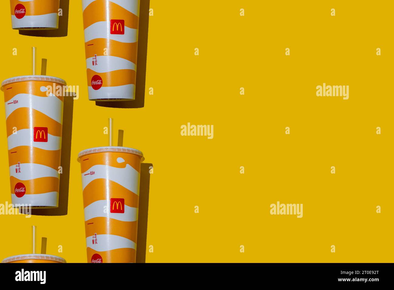Yellow glass of McDonald's. Paper cup with lid. Takeaway drink ...