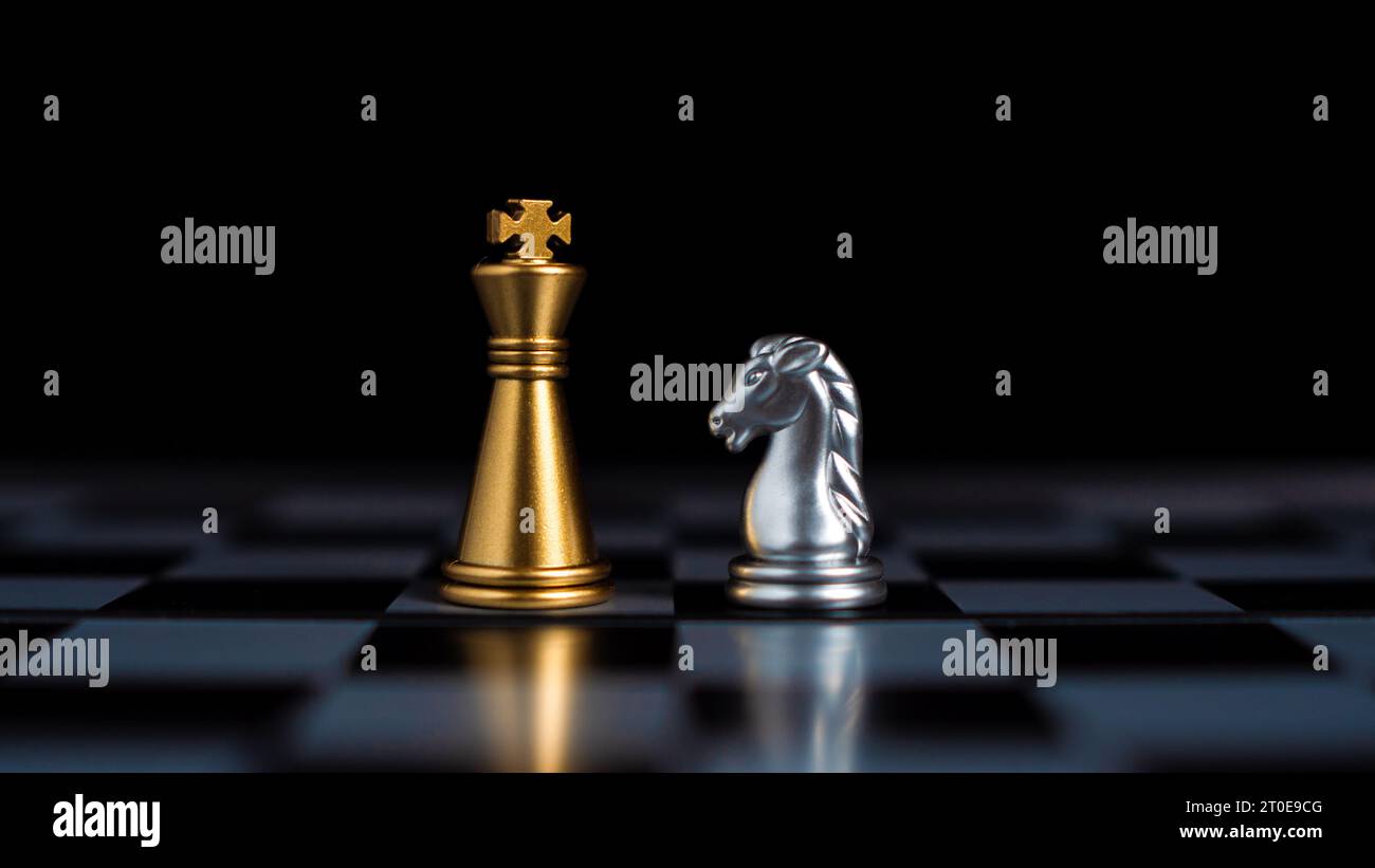 Gold and silver chess pieces in chess board game for business ...