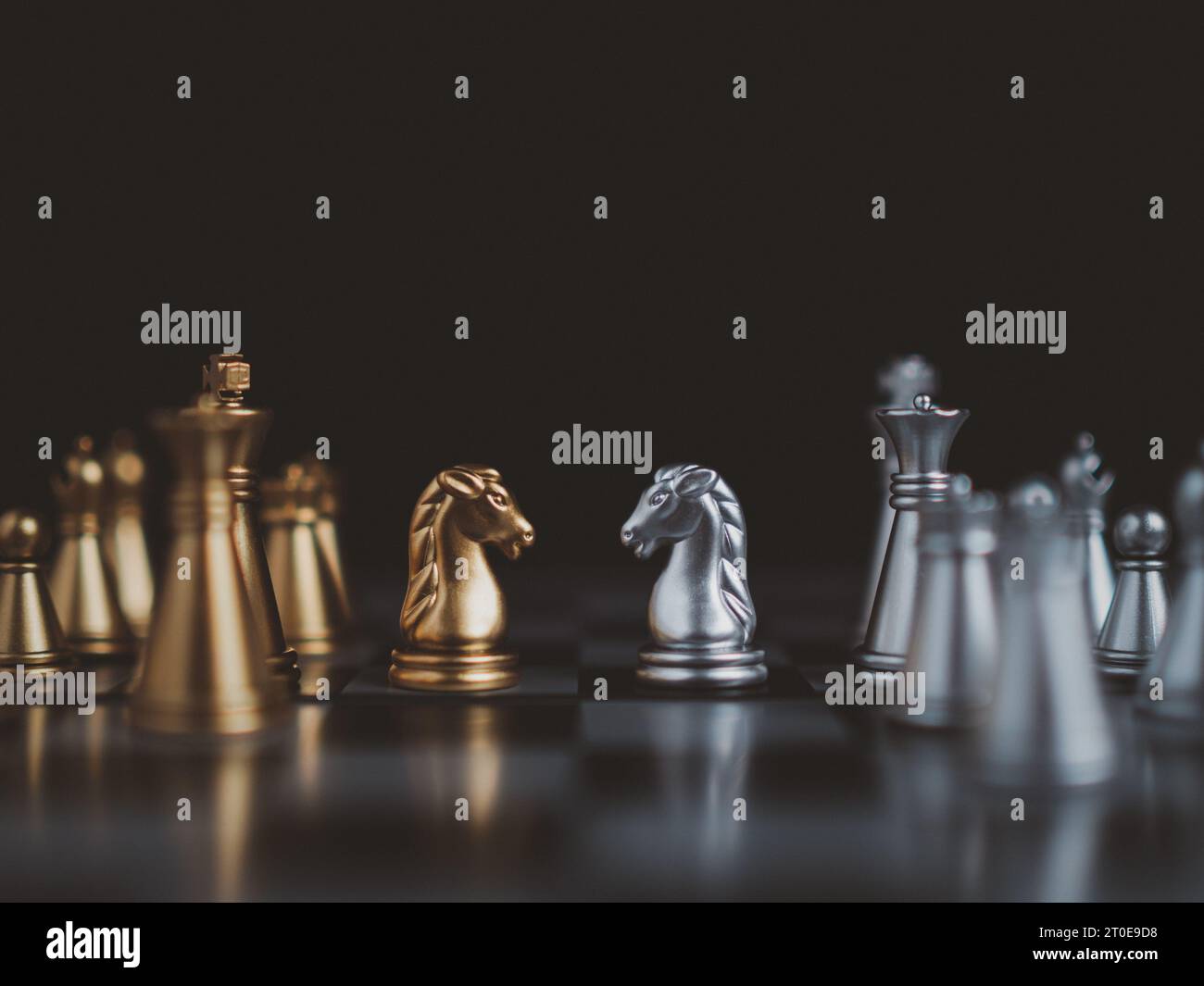 Gold and silver chess pieces in chess board game for business ...