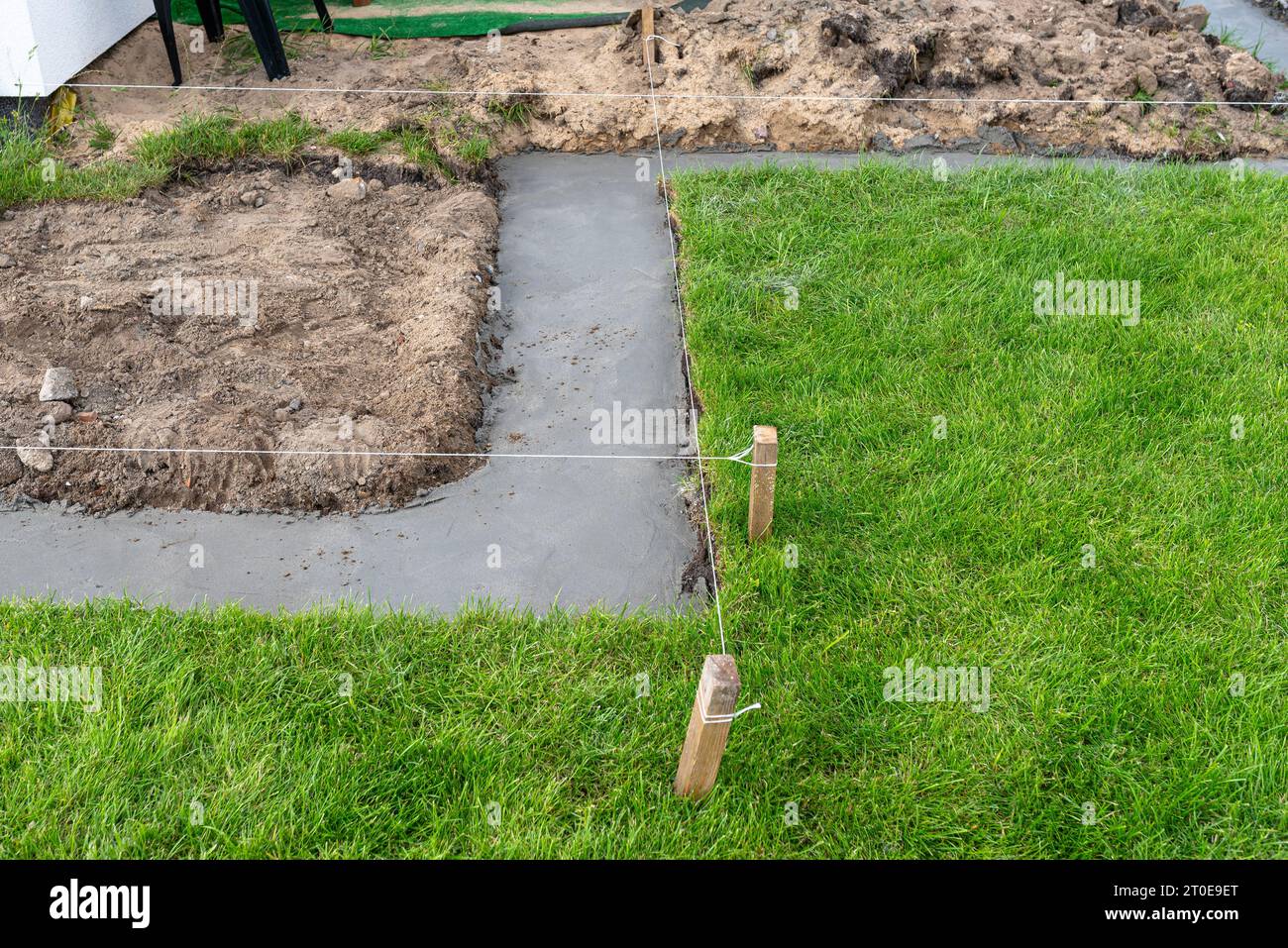 Foundation footings poured in a ditch in the yard, building a terrace ...