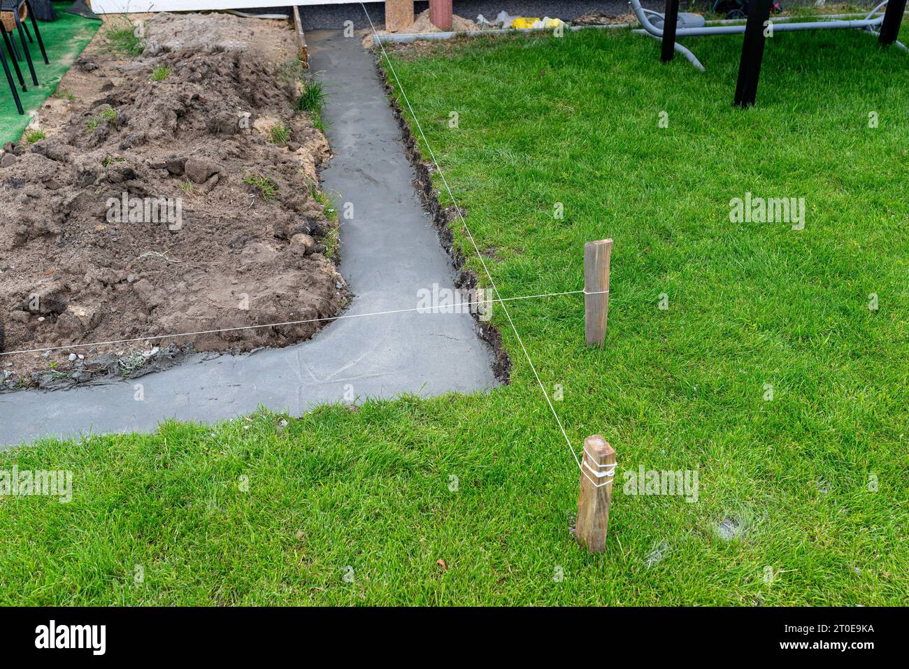 Foundation footings poured in a ditch in the yard, building a terrace ...