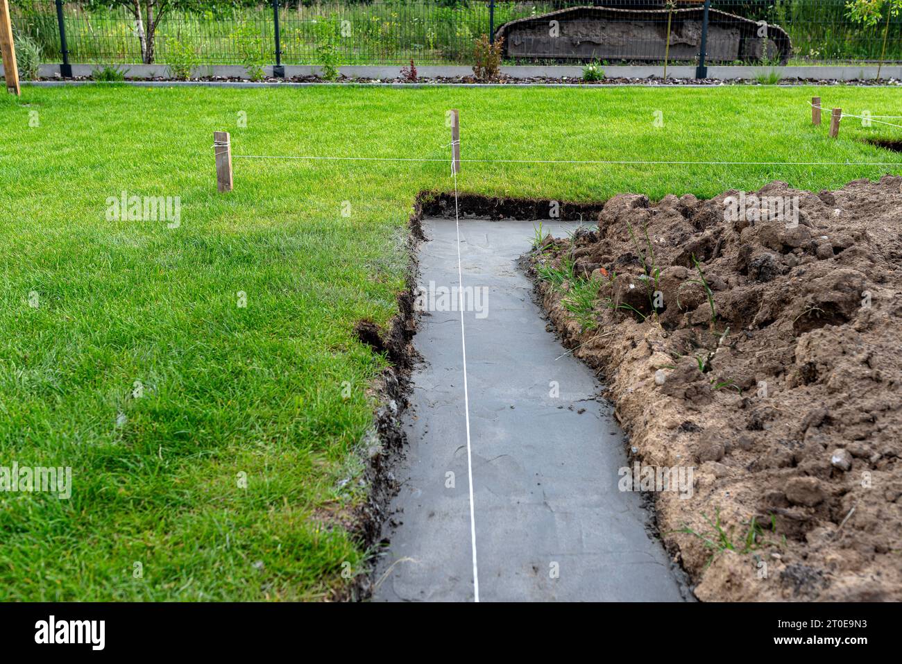 Foundation footings poured in a ditch in the yard, building a terrace ...
