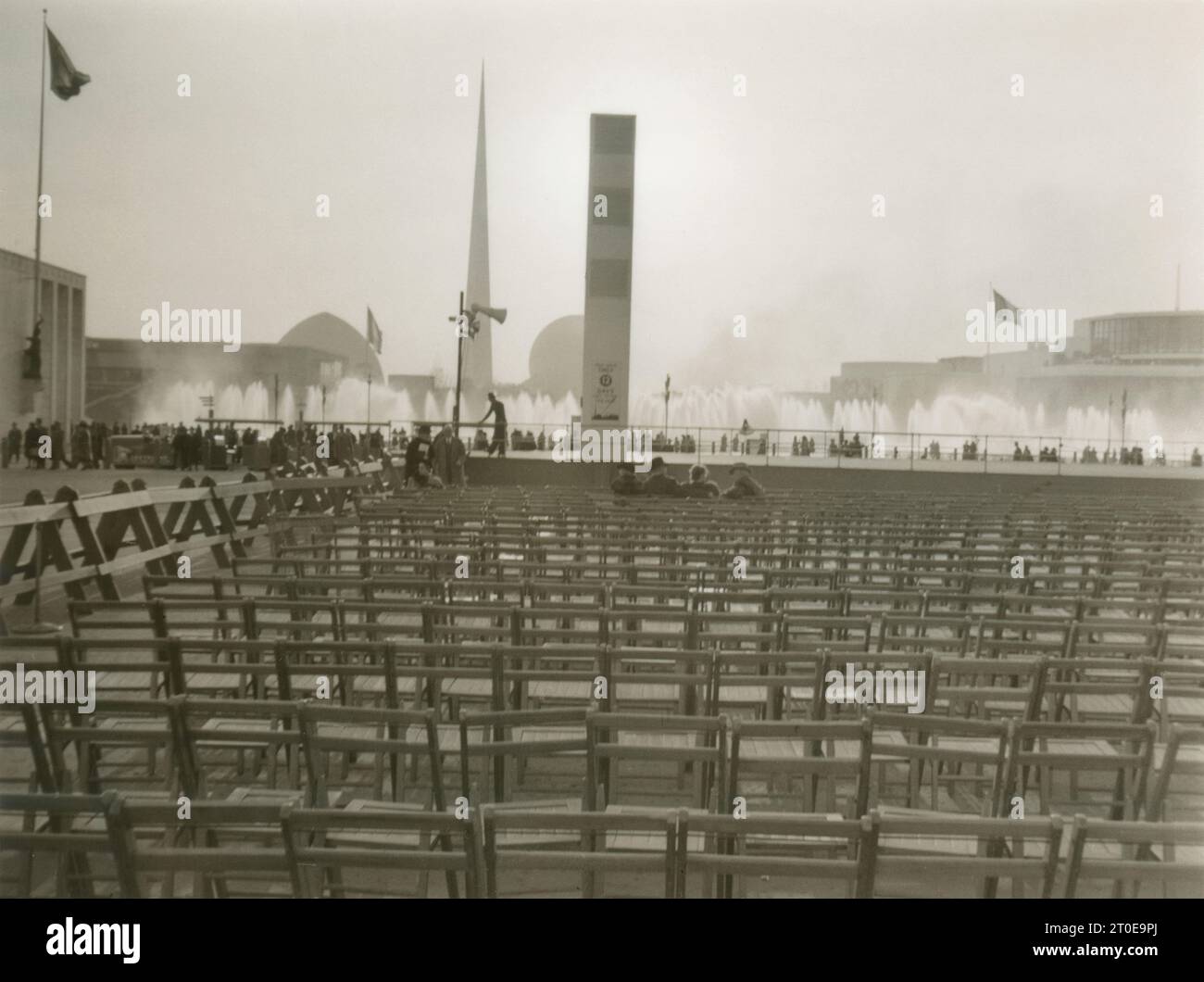 Antique photograph, rows of empty chairs with the Trylon and Perisphere ...
