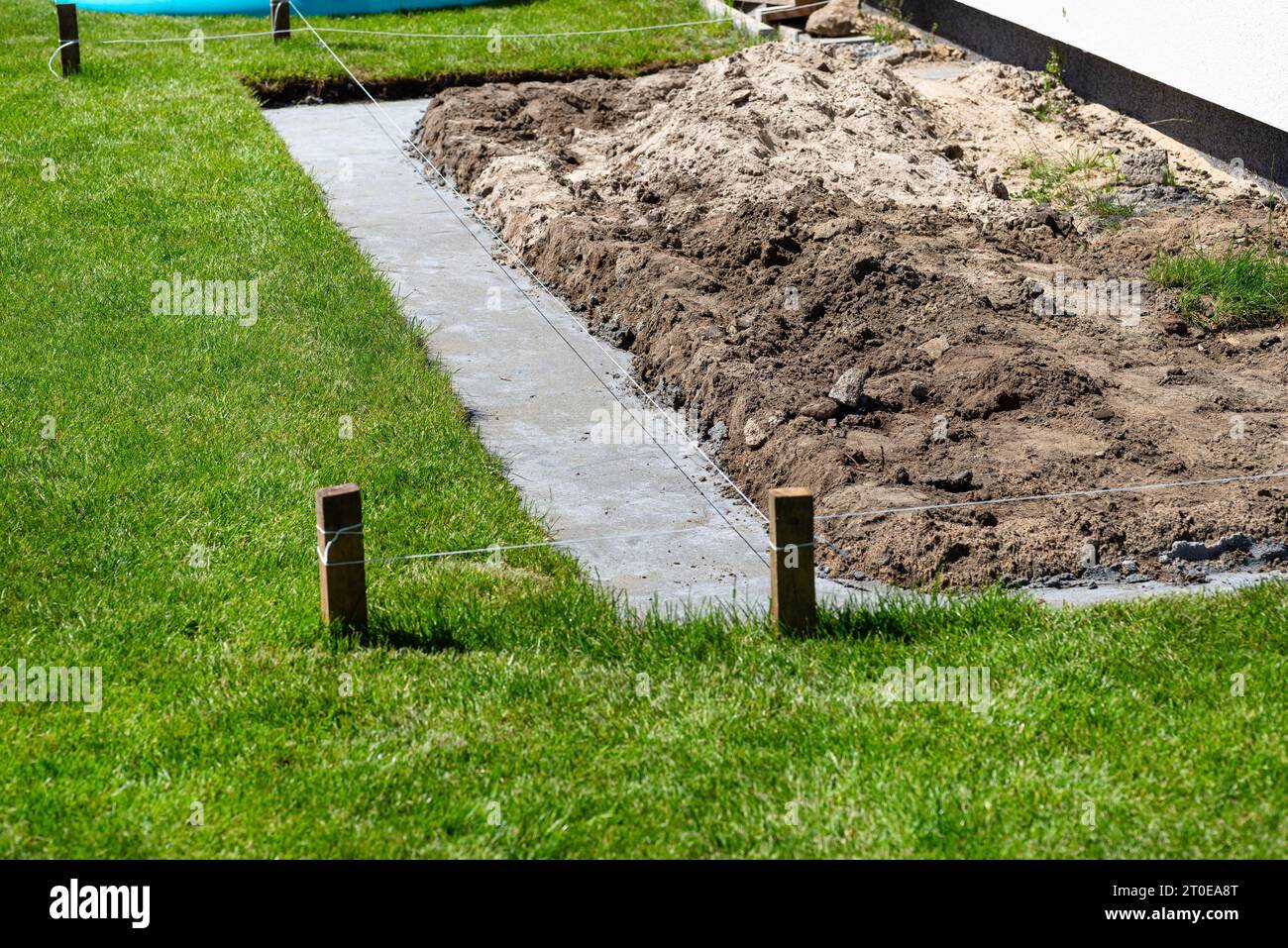 Foundation footings poured in a ditch in the yard, building a terrace ...