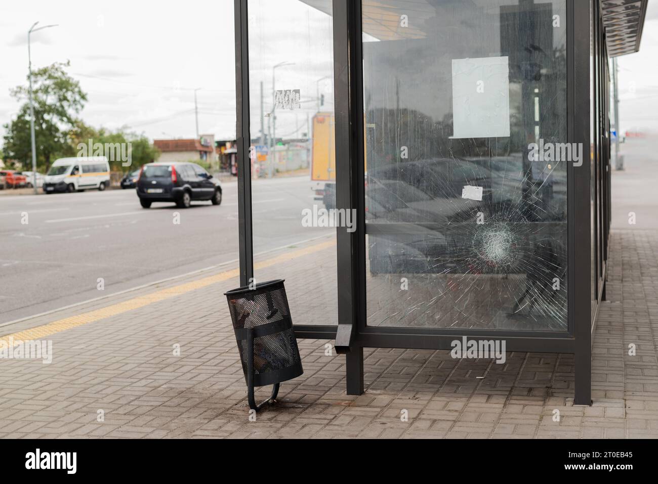Broken glass at the bus stop. Public transport station vandalised by ...