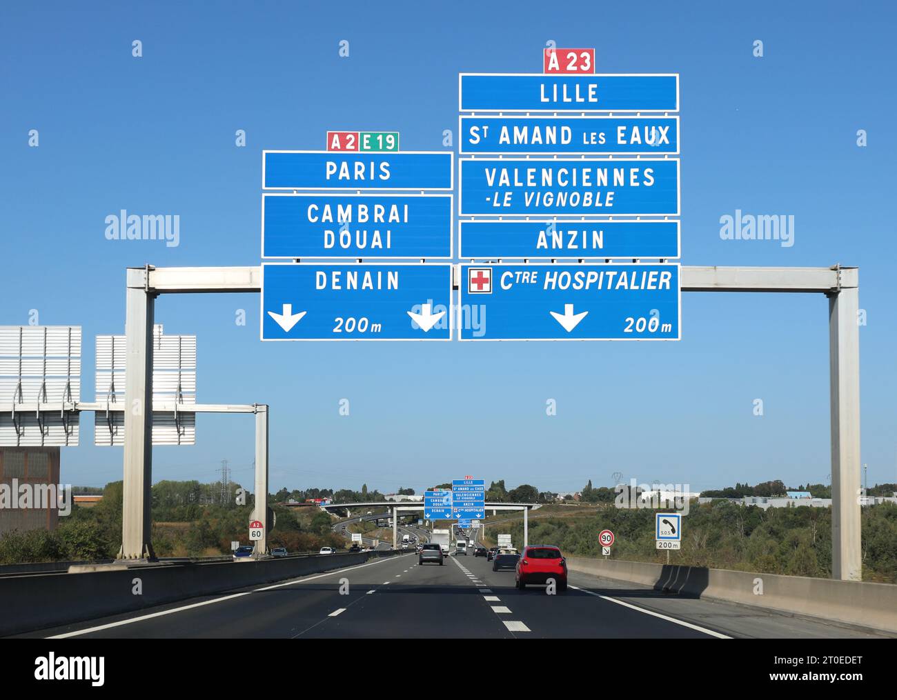 Road signs with French locations in the wide highway with three lanes ...