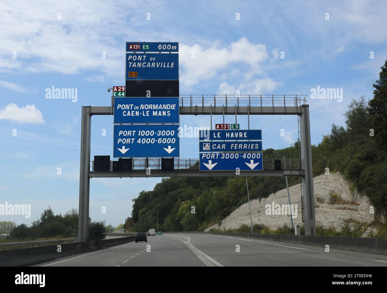 road signs with French locations on the wide motorway with directions ...