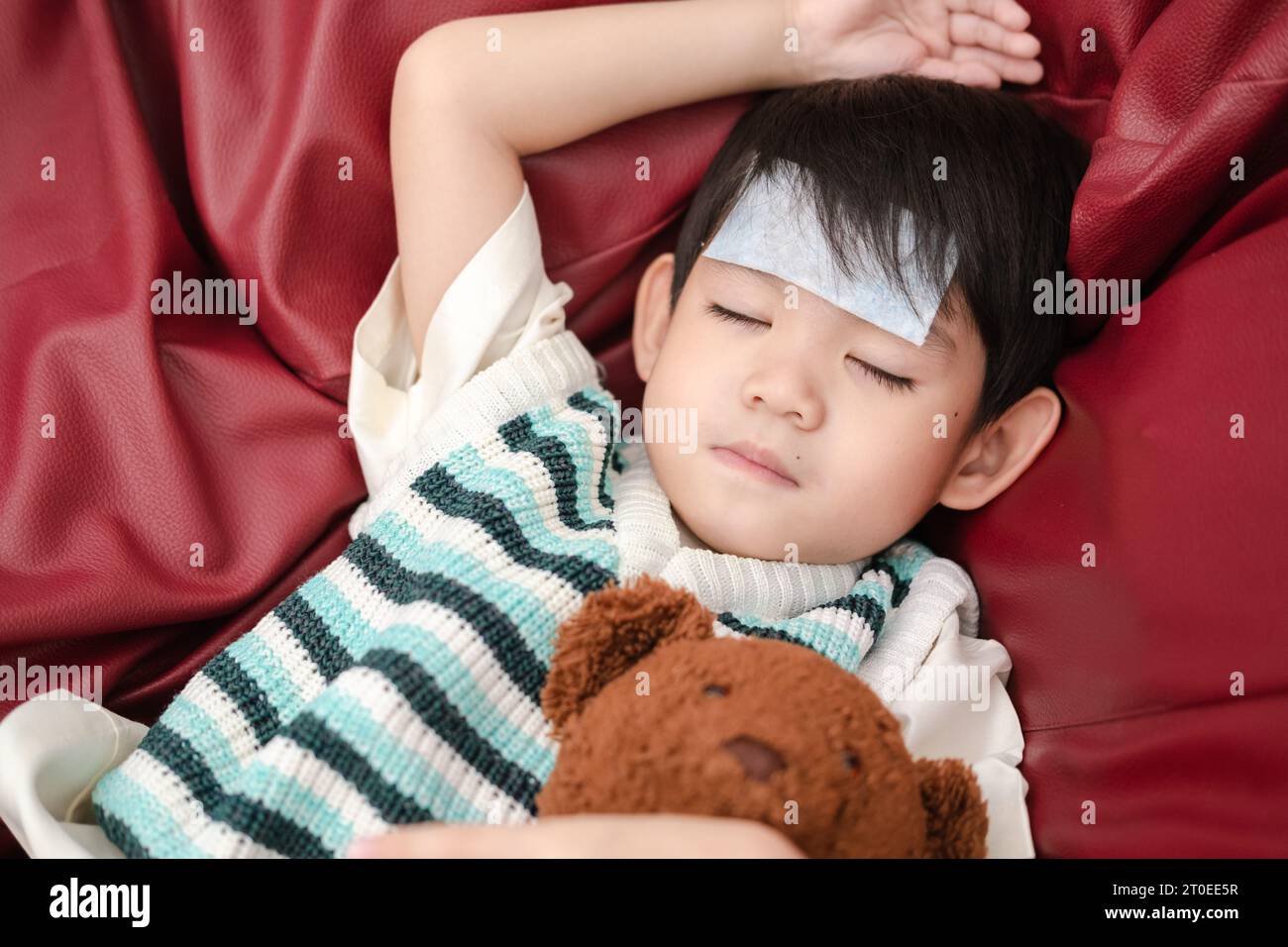 Asian boy She was sick and had a fever reducing patch on her forehead ...