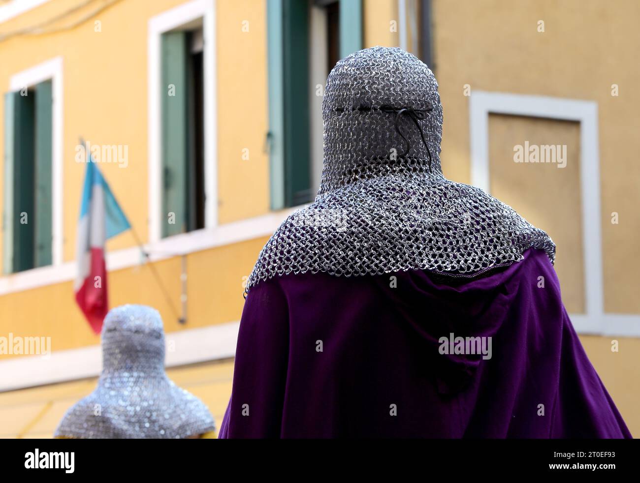 medieval knight with purple clothes and metal protection on the head ...