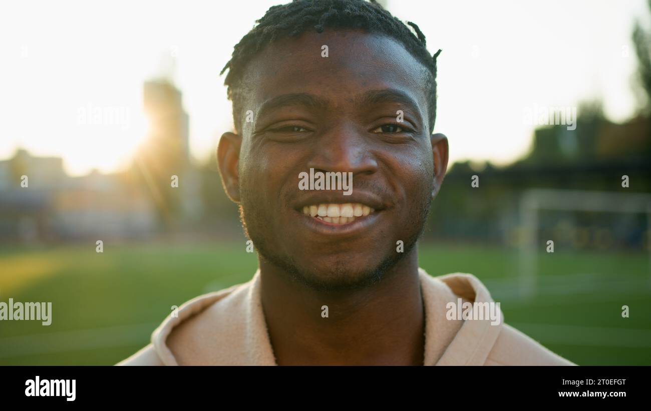 Male athlete portrait cheerful smiling ethnic young sportsman African ...