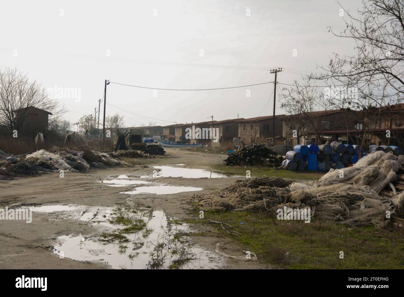 An old, dusty road lined with a variety of destroyed buildings in the ...