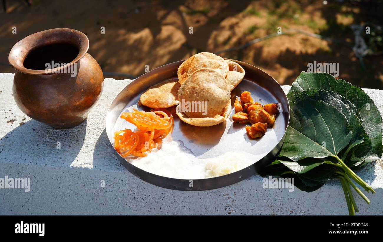 Indian religious family placed food on a leaf for the crow bird to eat ...