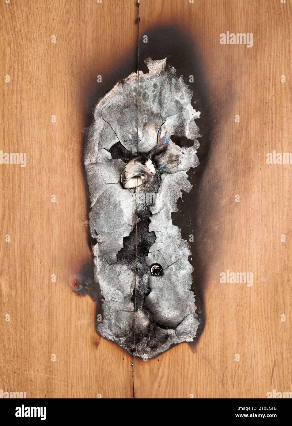 Burned door after building fire, close up. Front view of wooden ...