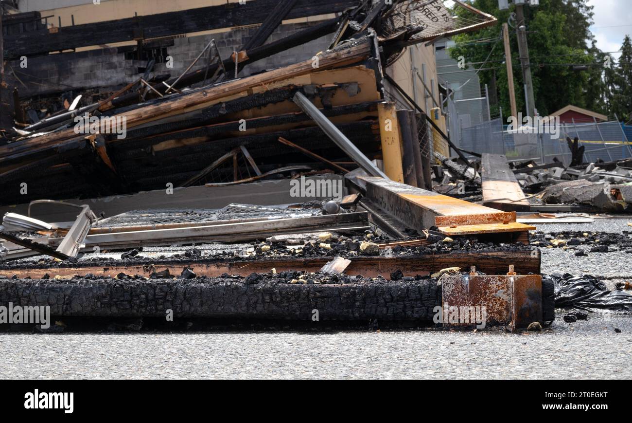 Burned building close up. Charred collapsed structure with wood beams ...