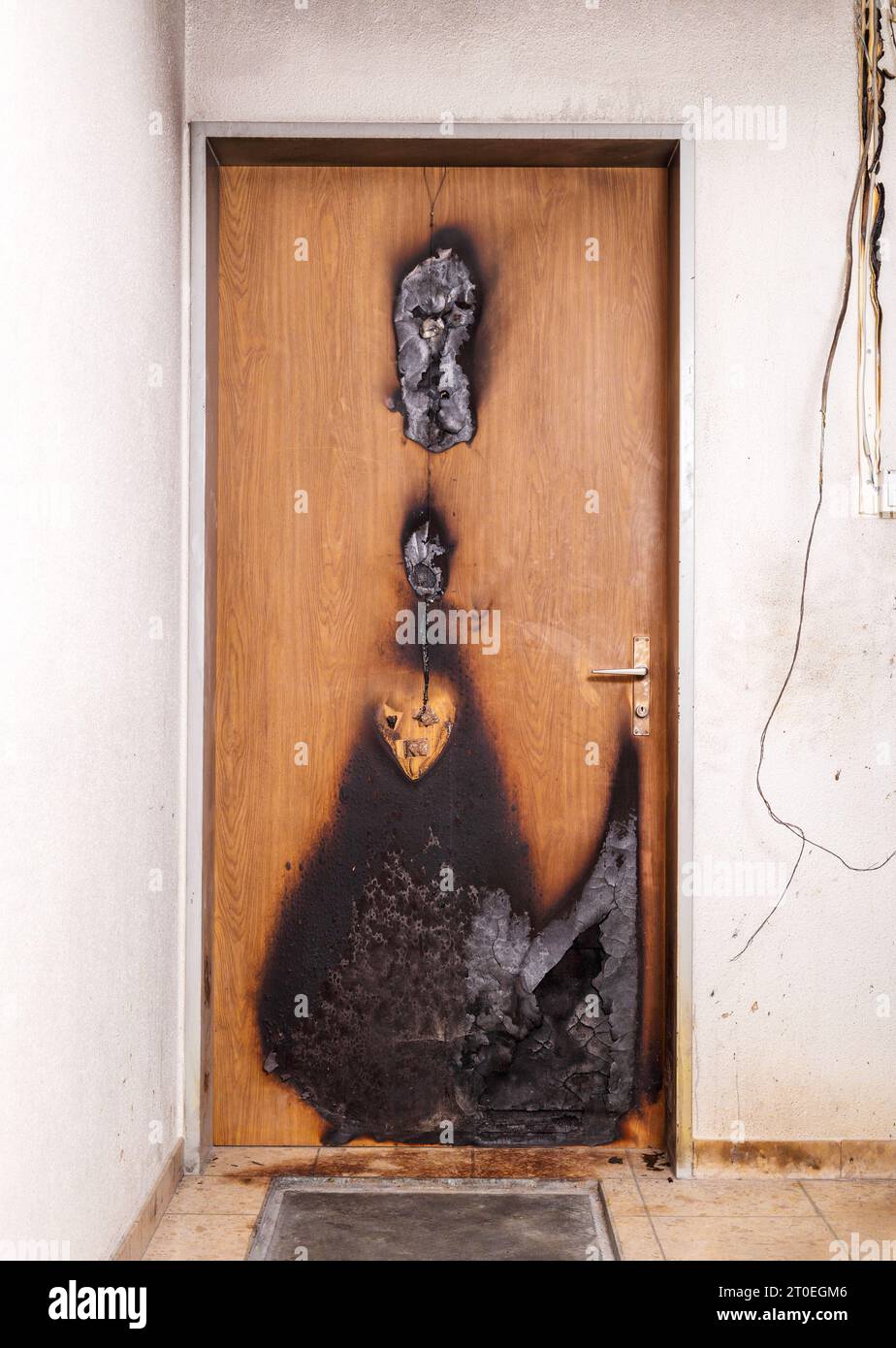 Burned door after building fire. Apartment front door charred, black ...