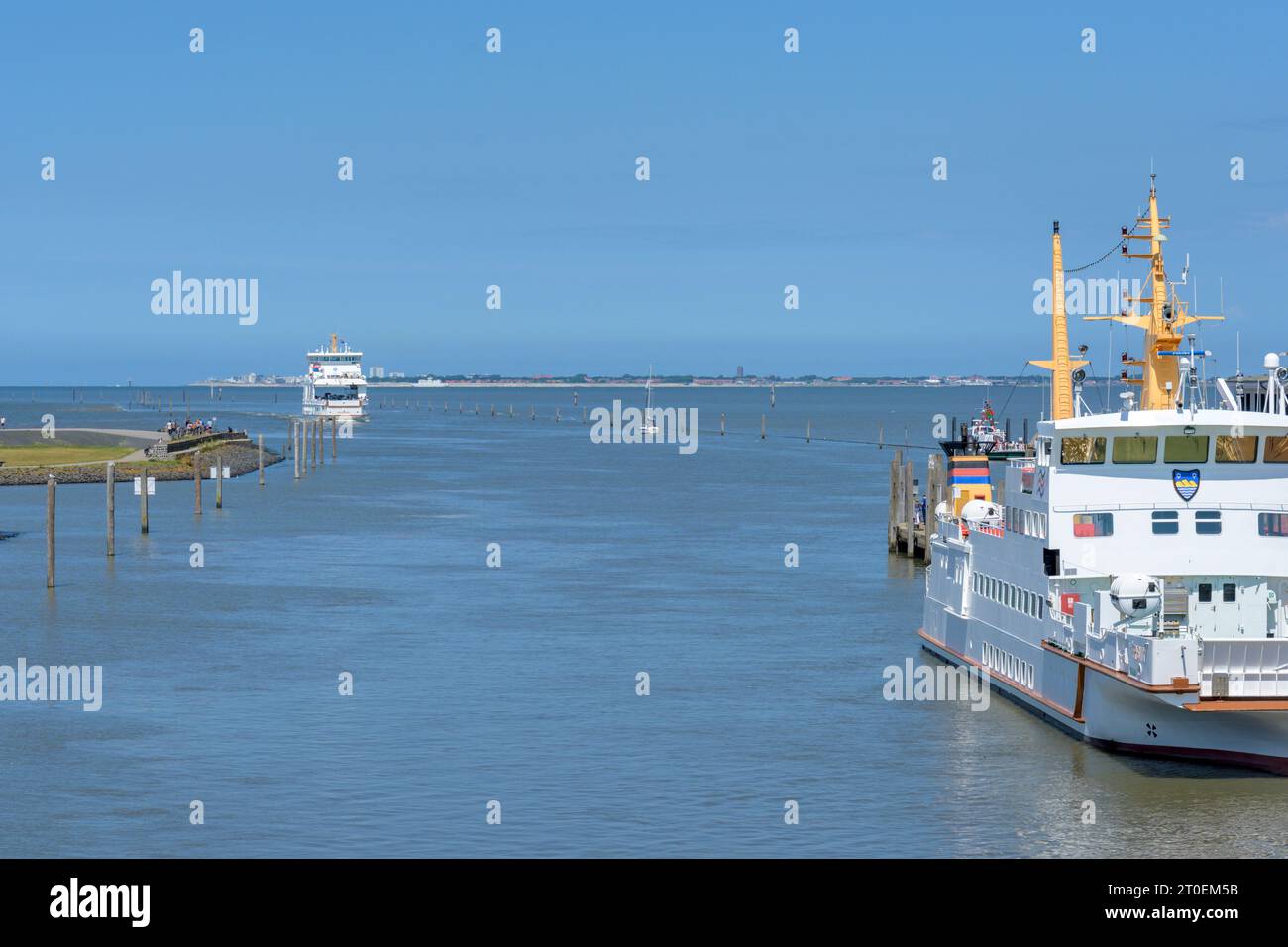 Germany, East Frisia, harbor of Norddeich with incoming Norderney ferry ...