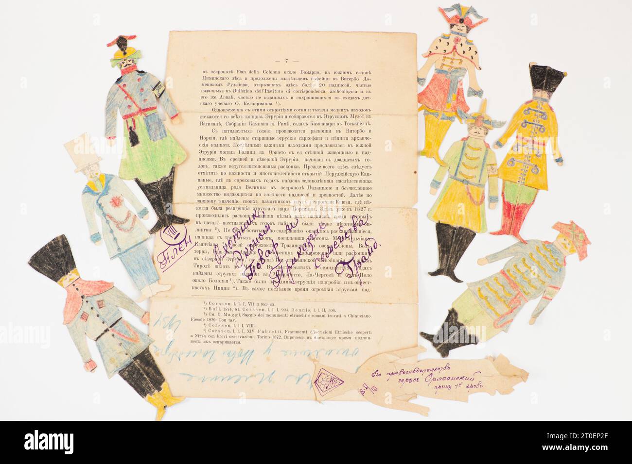 Handmade figures for childish play cut out from paper put in book page ...