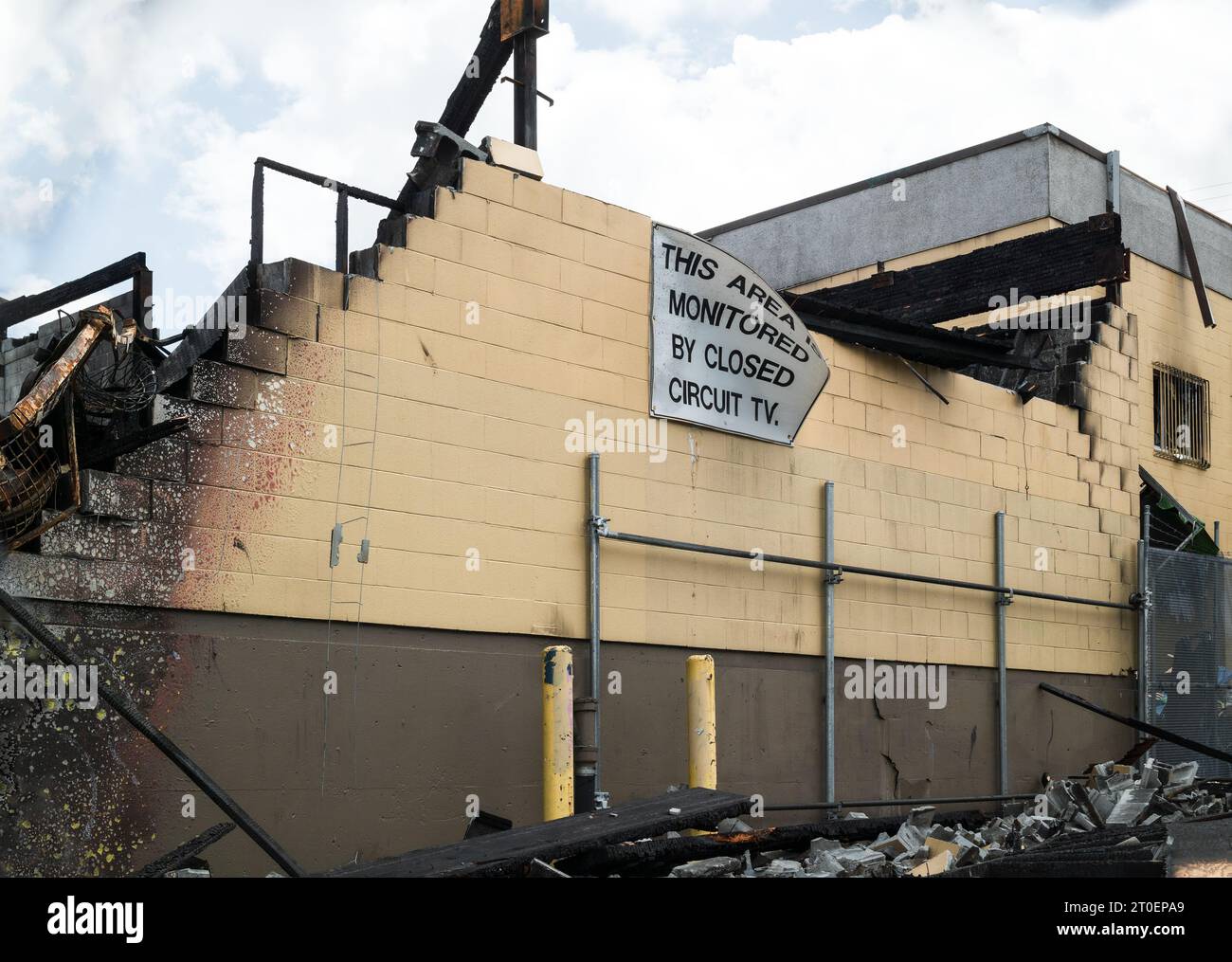 Burned brick wall the day after building burned to the ground. Melted ...