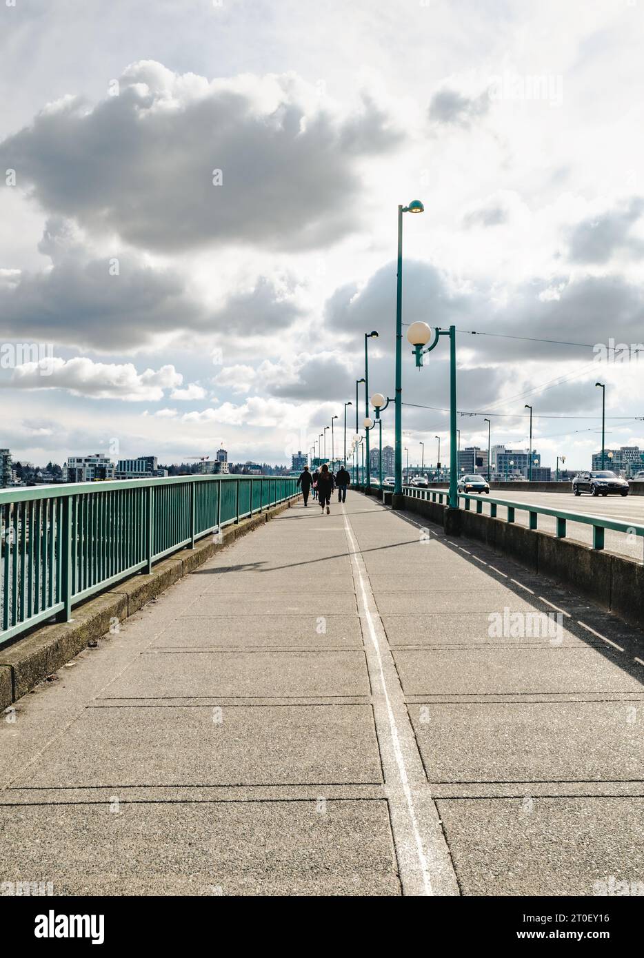 Back view of pedestrian crossing bridge with city background on a sunny ...